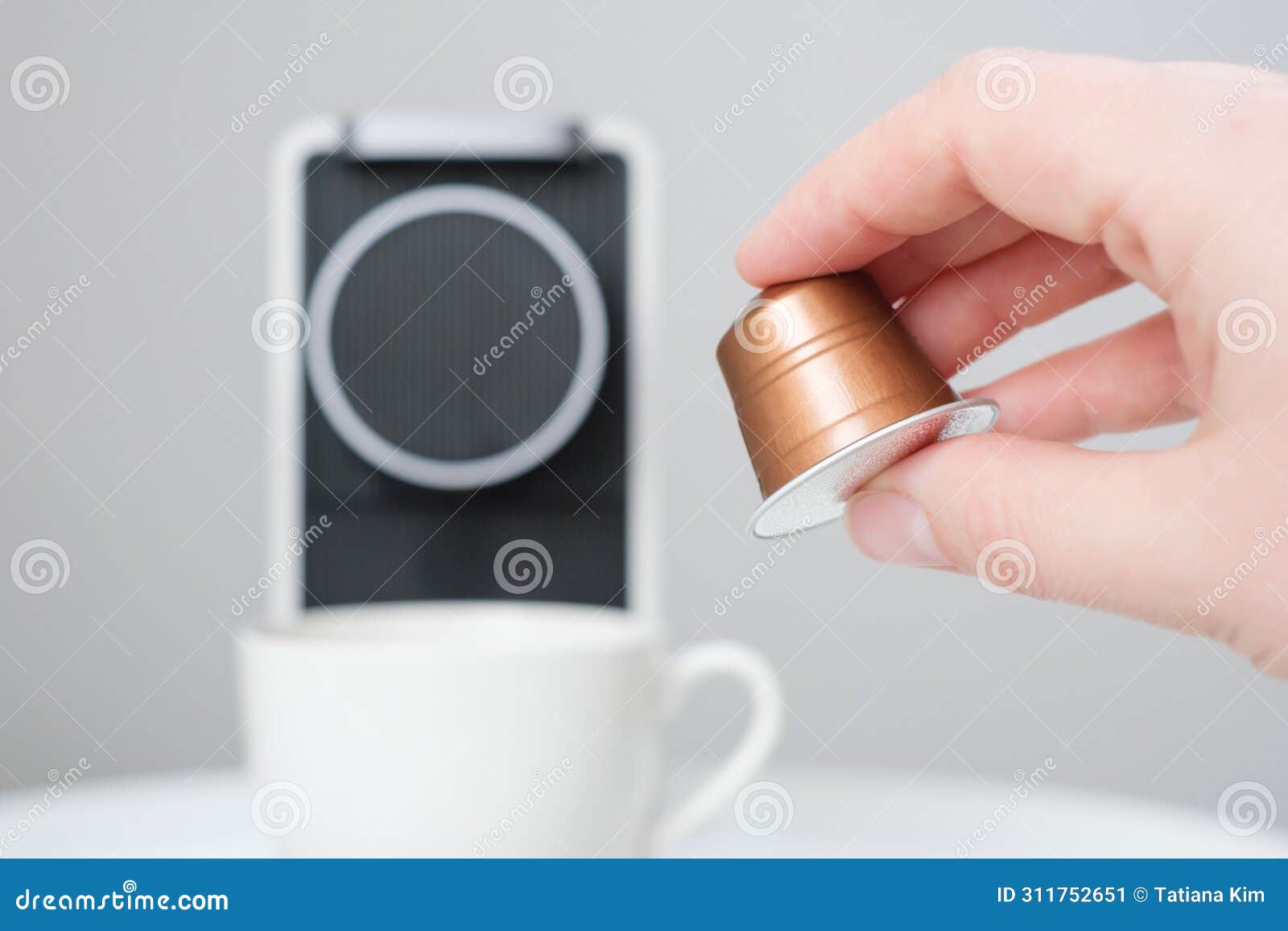 Female Hand Hold Capsule for a Coffee Machine on Gray Background. Stock ...