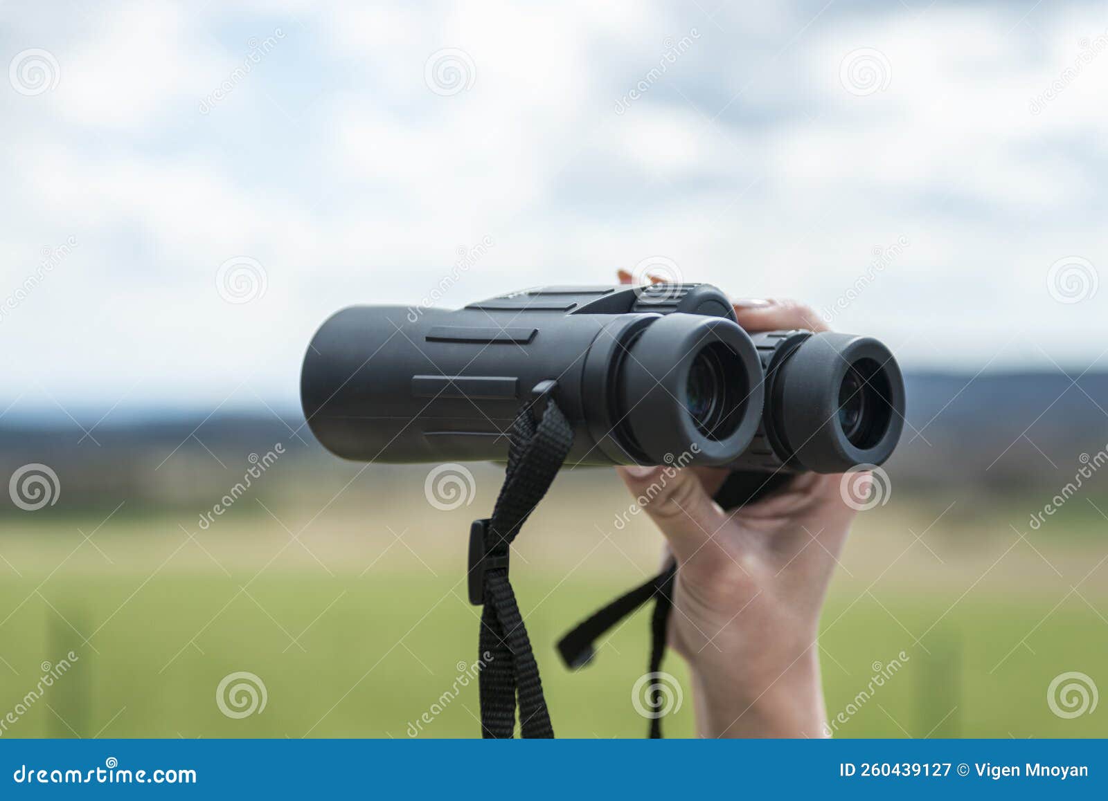 Hand holding a binoculars stock image. Image of view - 260439127