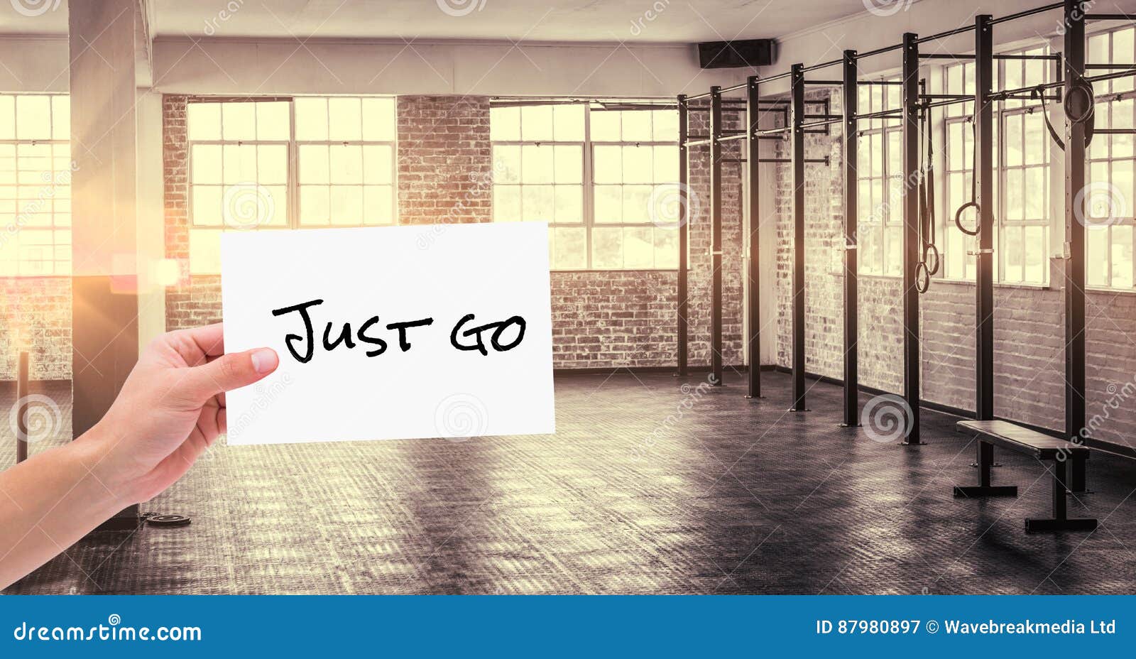 Female Hand Holding a Card with Text Just Go in Gym Stock Image - Image ...