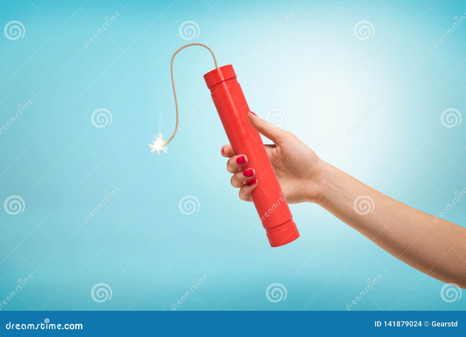 A Female Hand Holding a Dynamite Stick with a Burning Wick on Blue ...