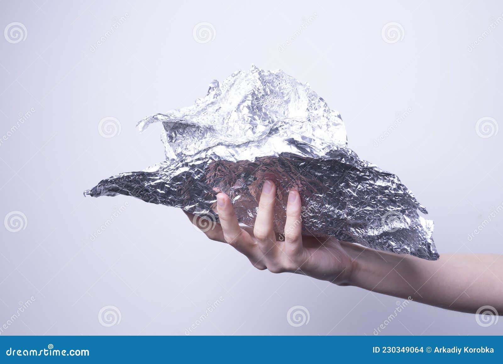 Female Hand Holding Foil Packaging on Gray Background Stock Photo ...