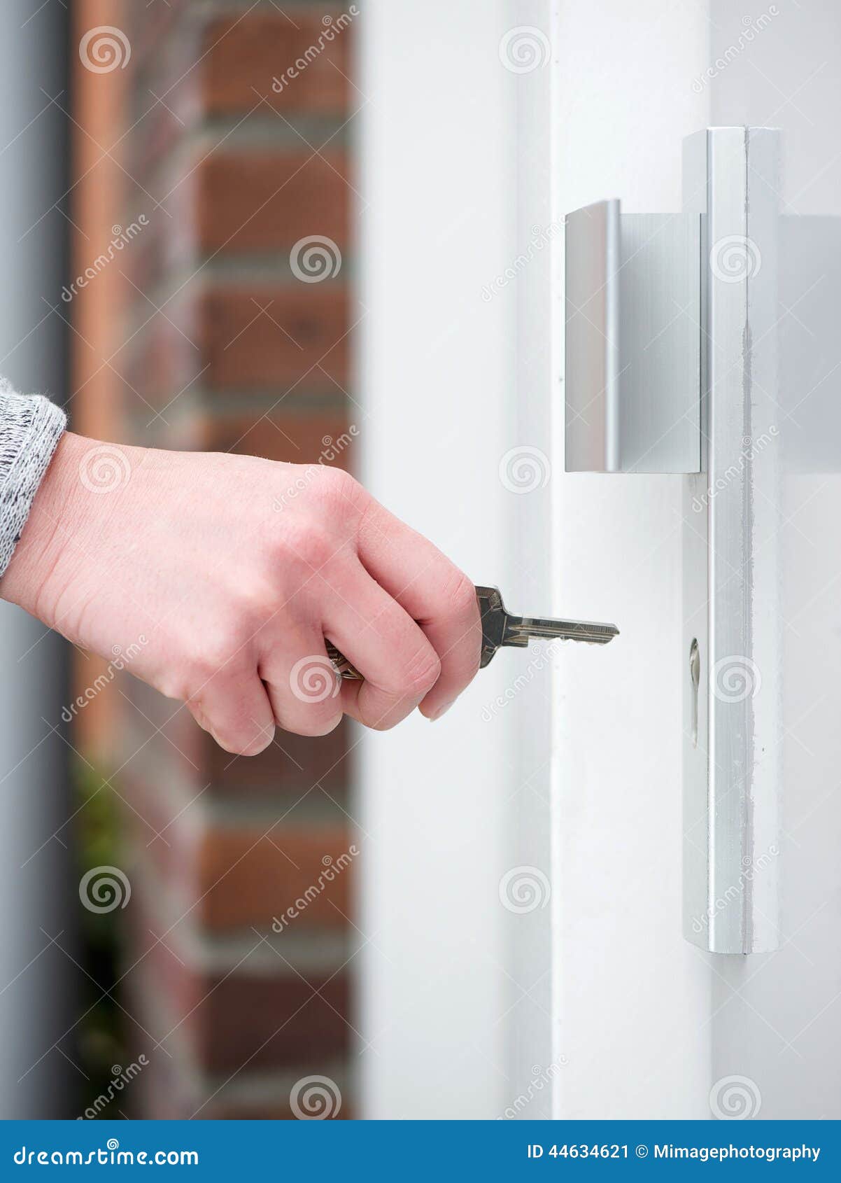 Female Hand Holding Key To Insert in Door Lock Stock Image - Image of ...