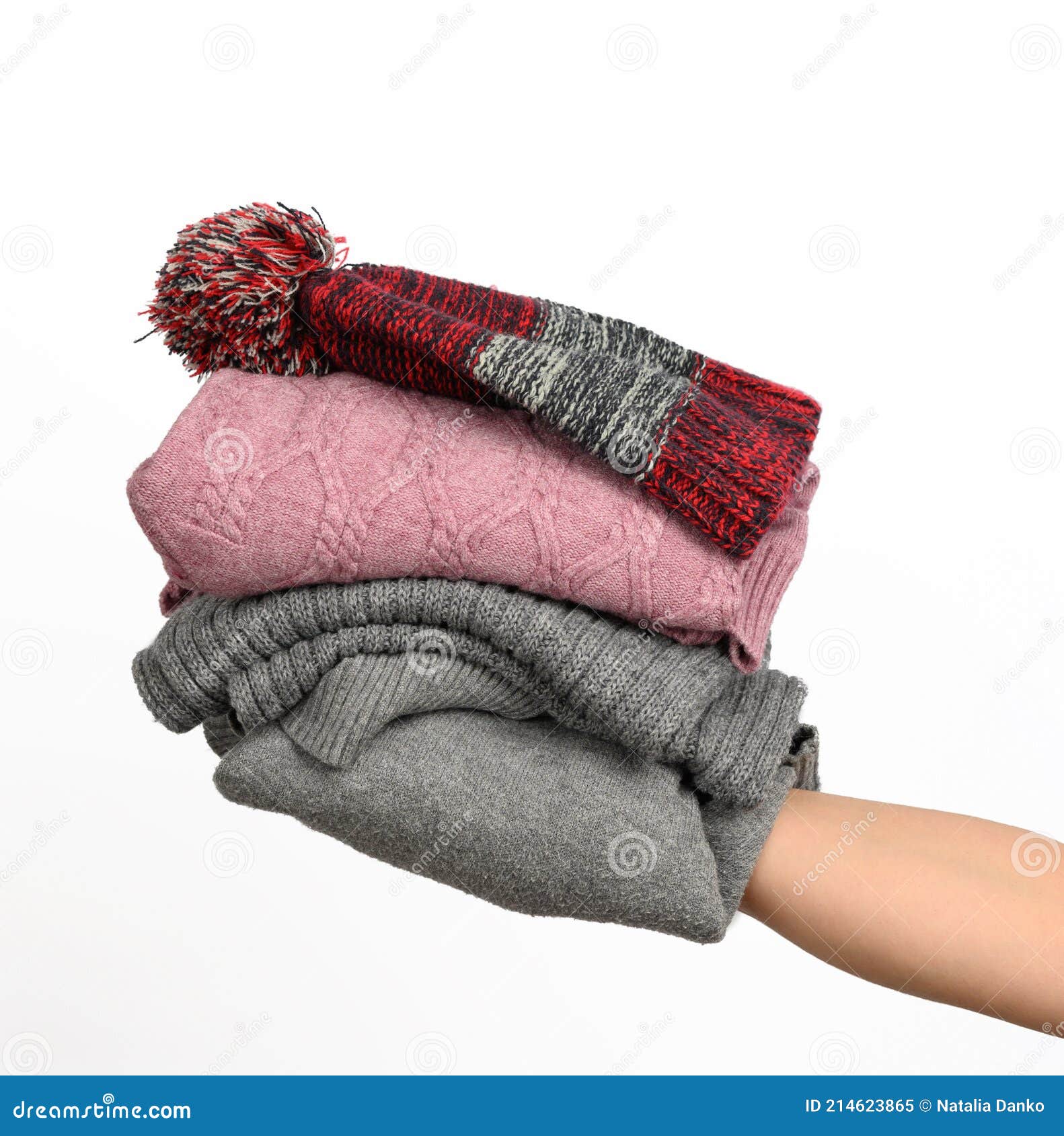 Female Hand Holding a Stack of Clothes, Help and Volunteering Concept ...