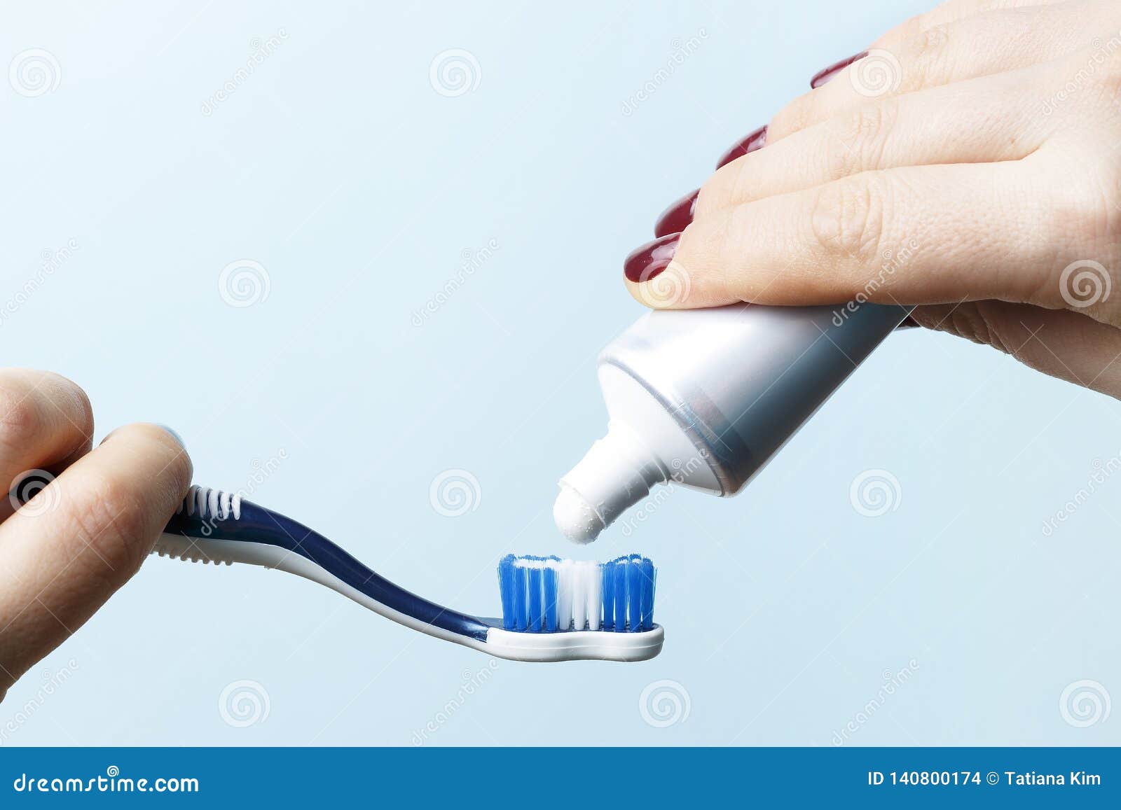 Female Hand Holding a Toothbrush and Squeezing Toothpaste Stock Photo ...
