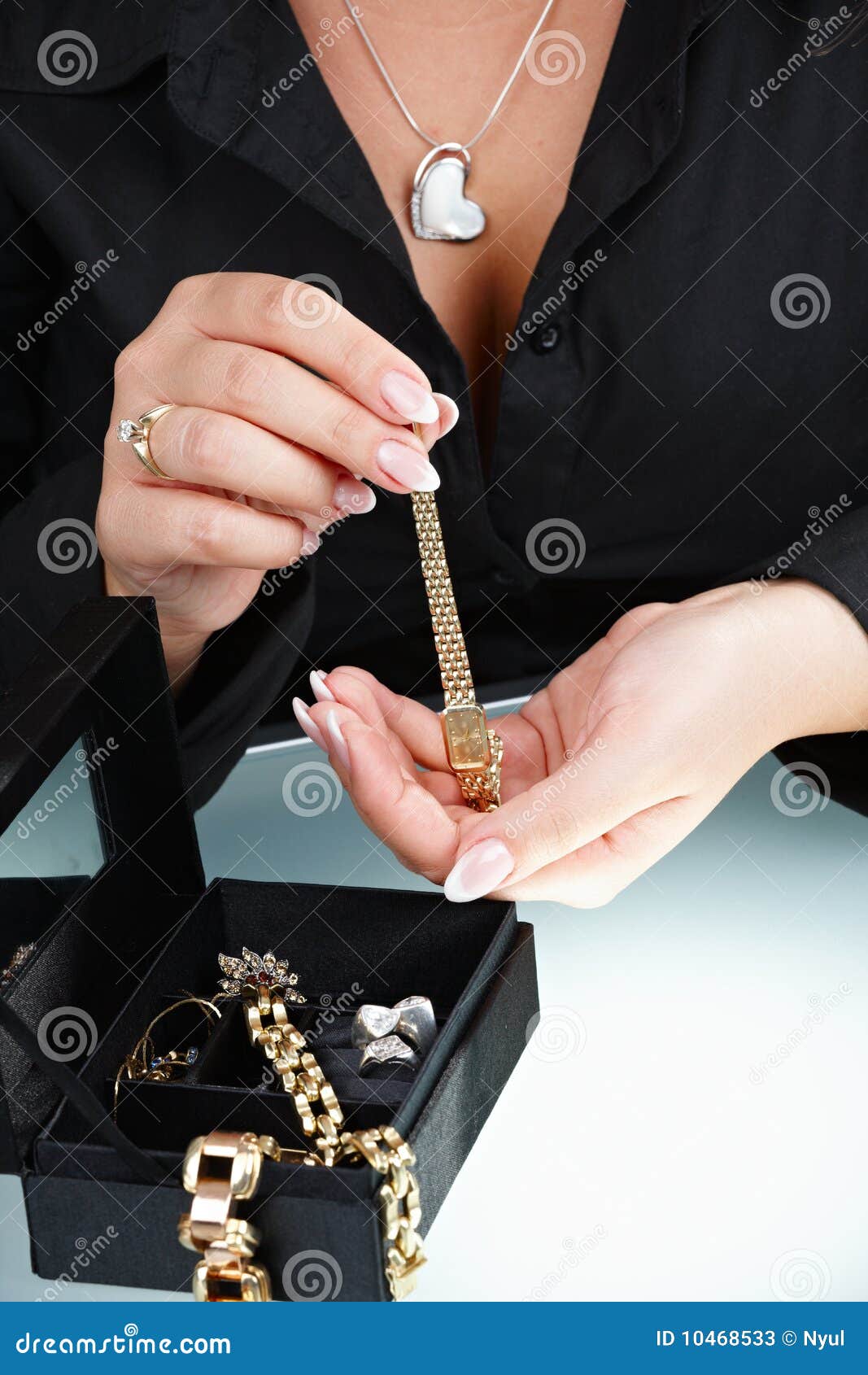 Female hand holding watch stock image. Image of necklace - 10468533
