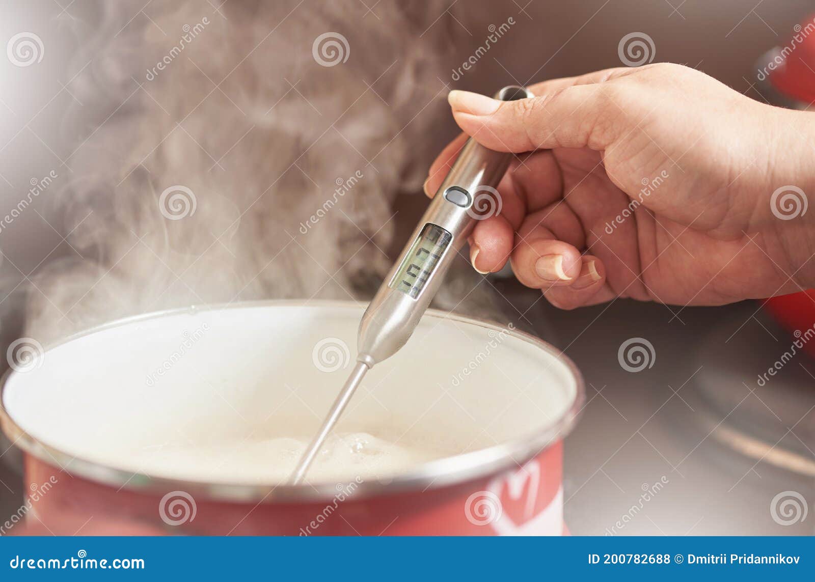 Female Hand Measures the Temperature in the Pan with an Electronic ...