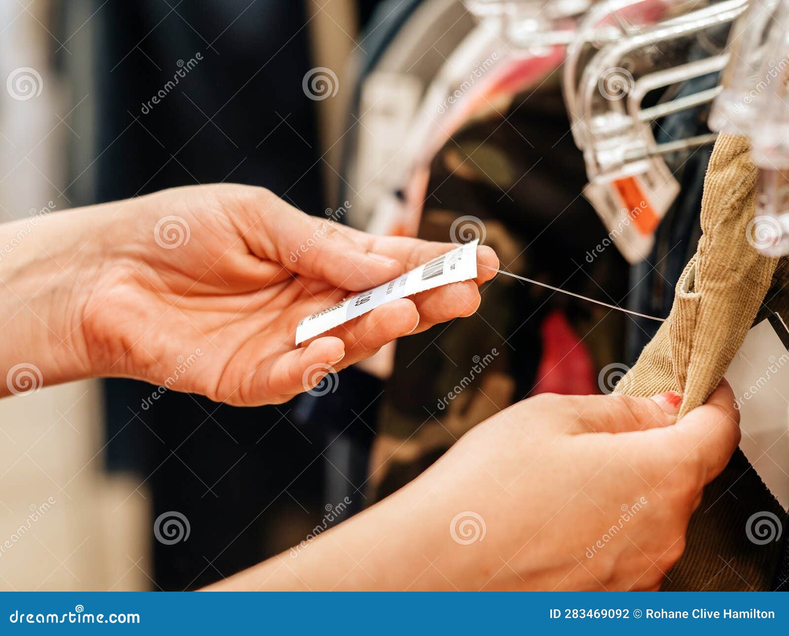 Female Hand Picking through Clothes on a Store Rack Stock Photo - Image ...