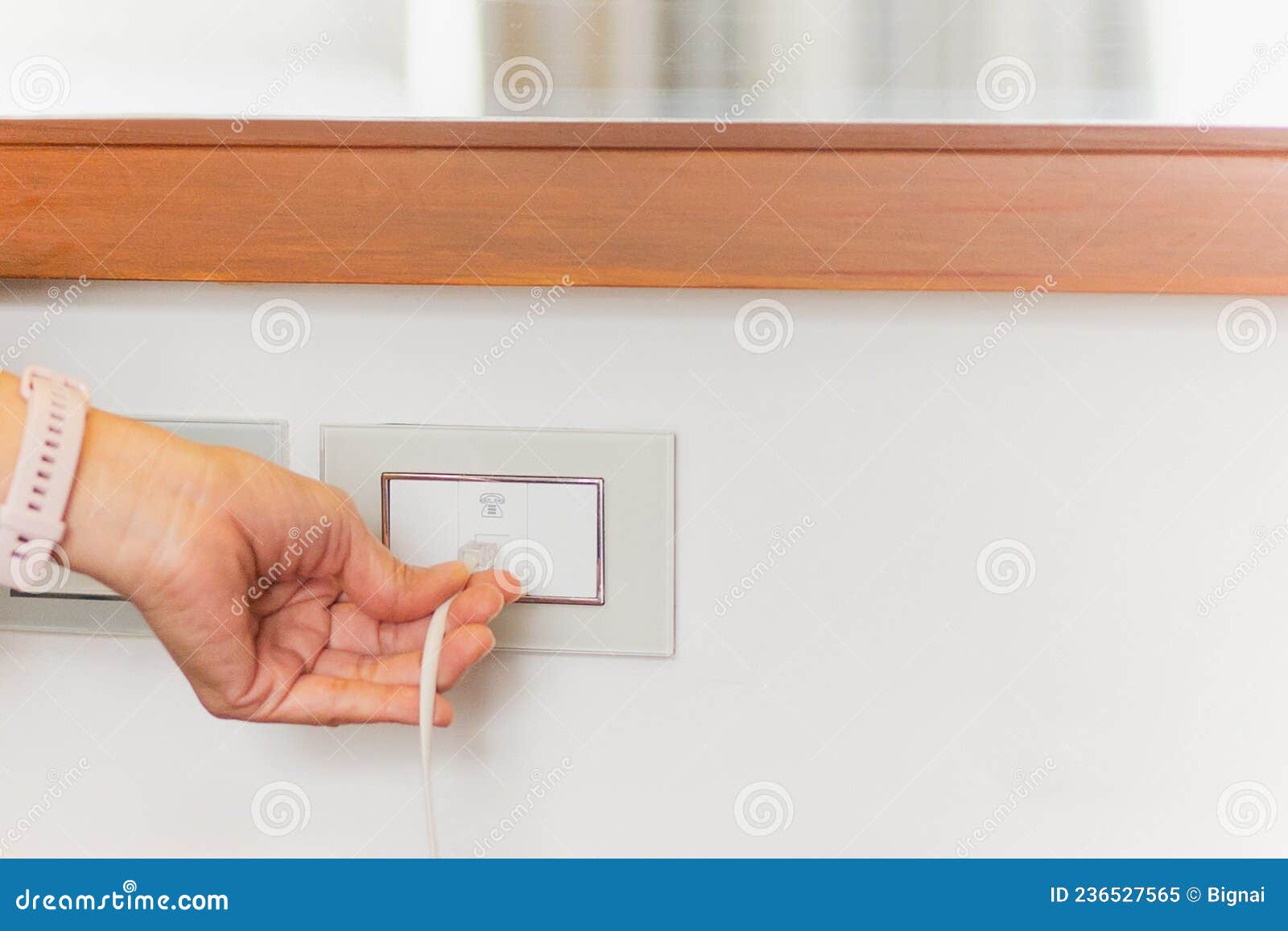 Female Hand Plug in Internet Cable Wire into Socket on the Wall. Stock ...