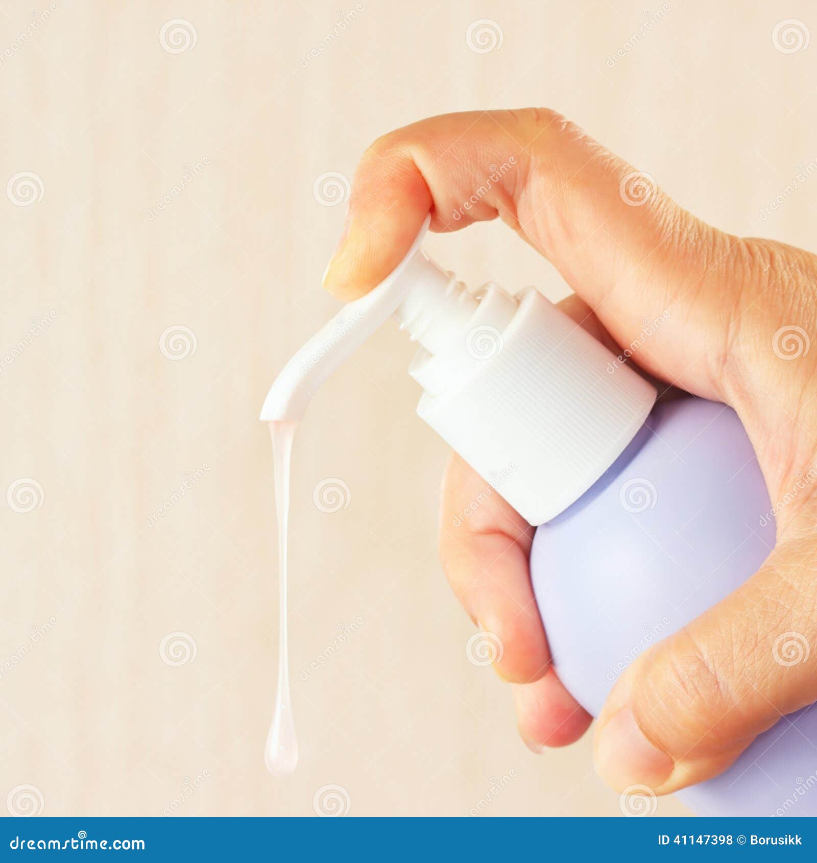 Female Hand Squeezing Liquid Soap from Bottle Stock Photo - Image of ...