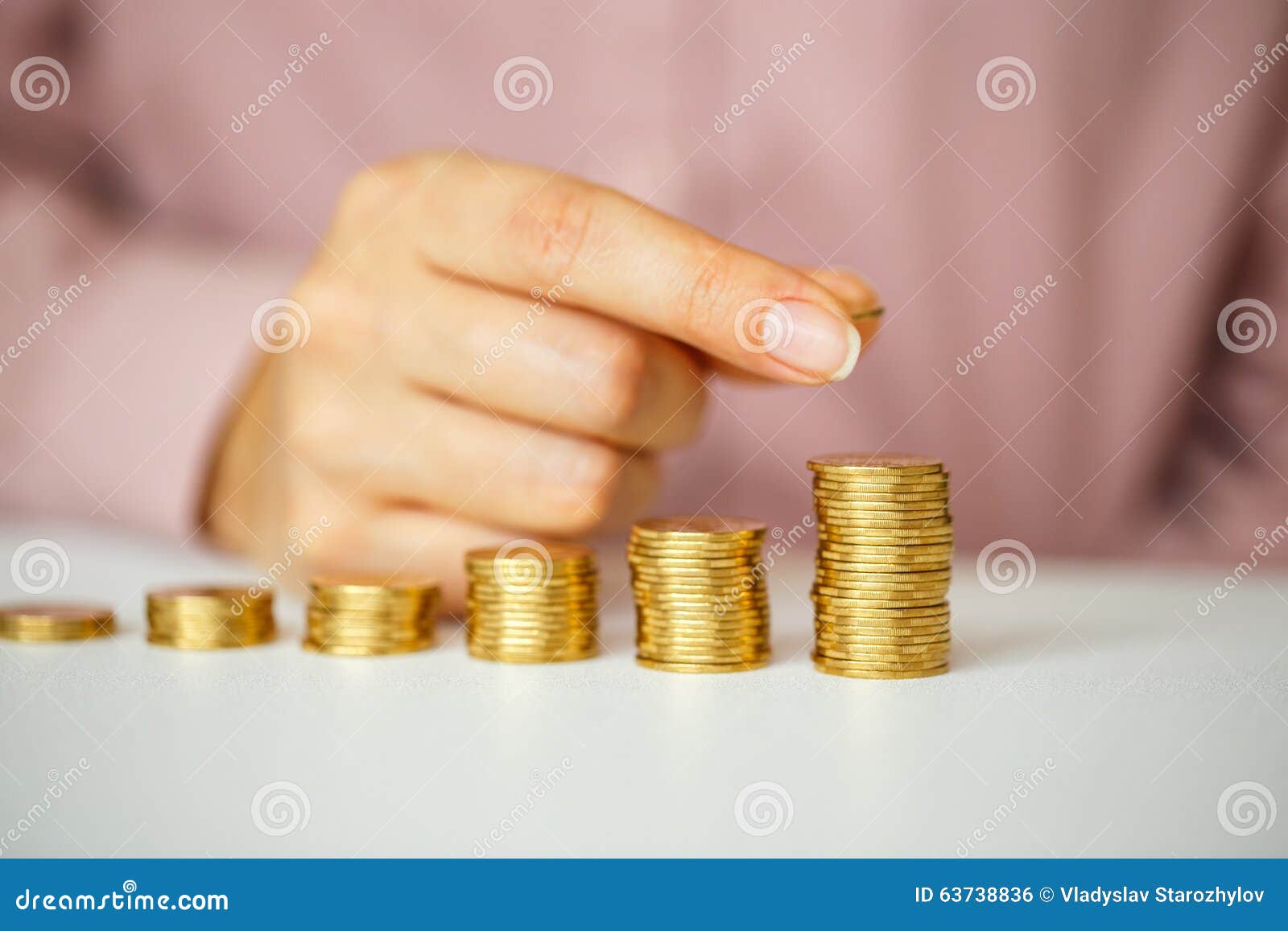 Female Hand Stacking Gold Coins into Increasing Columns Stock Photo ...