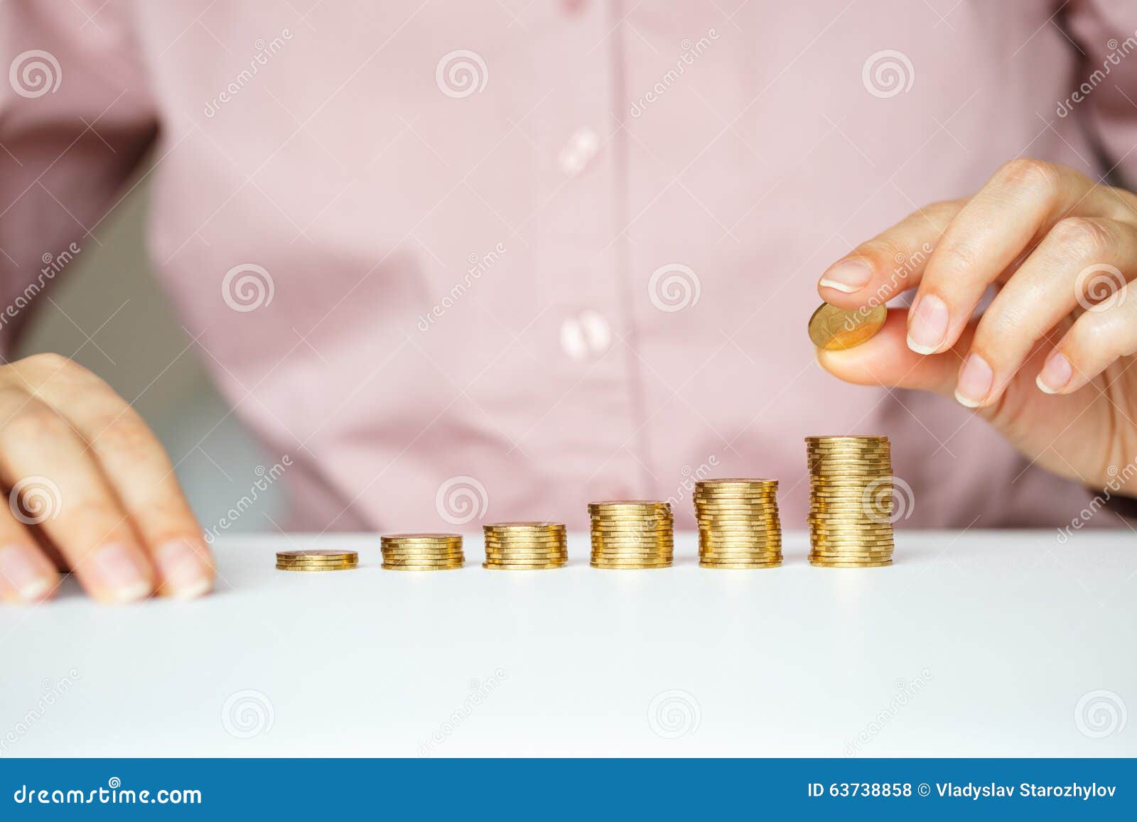 Female Hand Stacking Gold Coins into Increasing Columns Stock Photo ...
