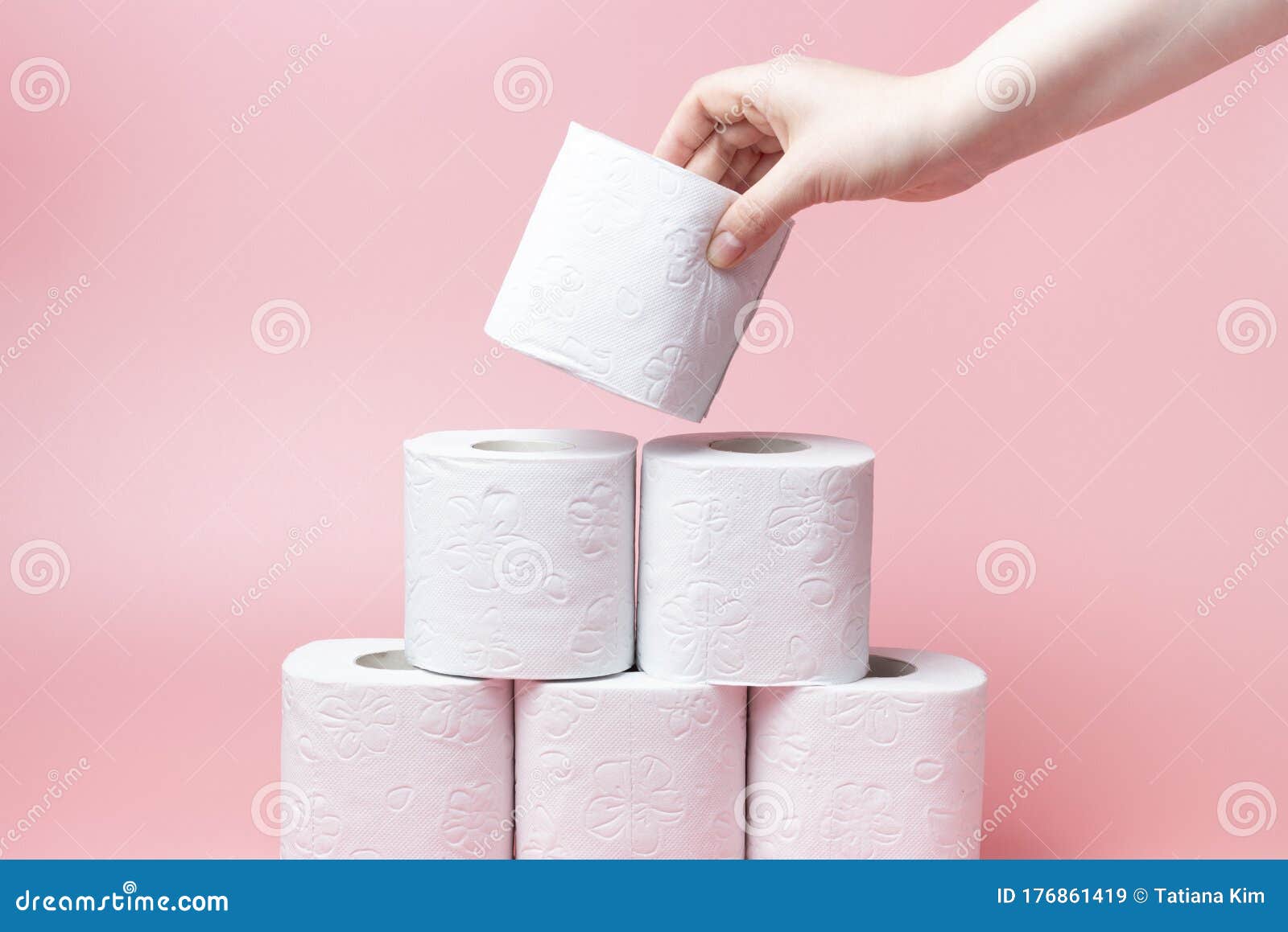 Female Hand Stacks Toilet Paper in a Stack on Pink Background Close-up ...