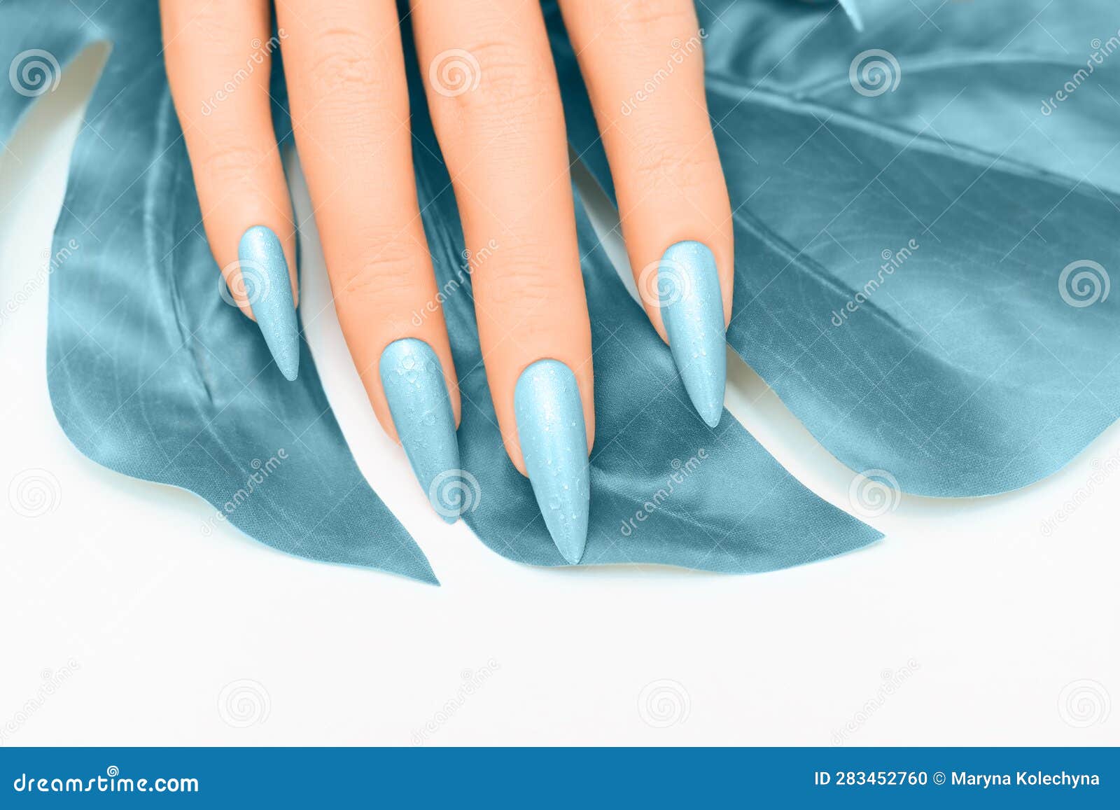 Female Hand With Stiletto Nail Design Glitter Blue Nail Polish
