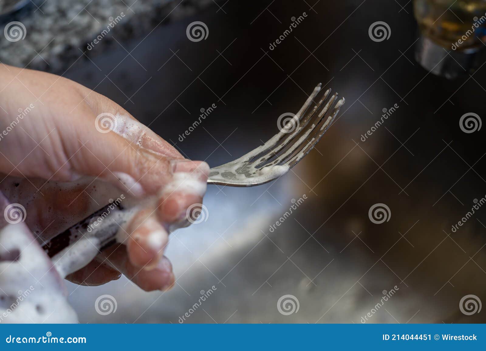 Female hand washing a fork stock image. Image of tableware - 214044451