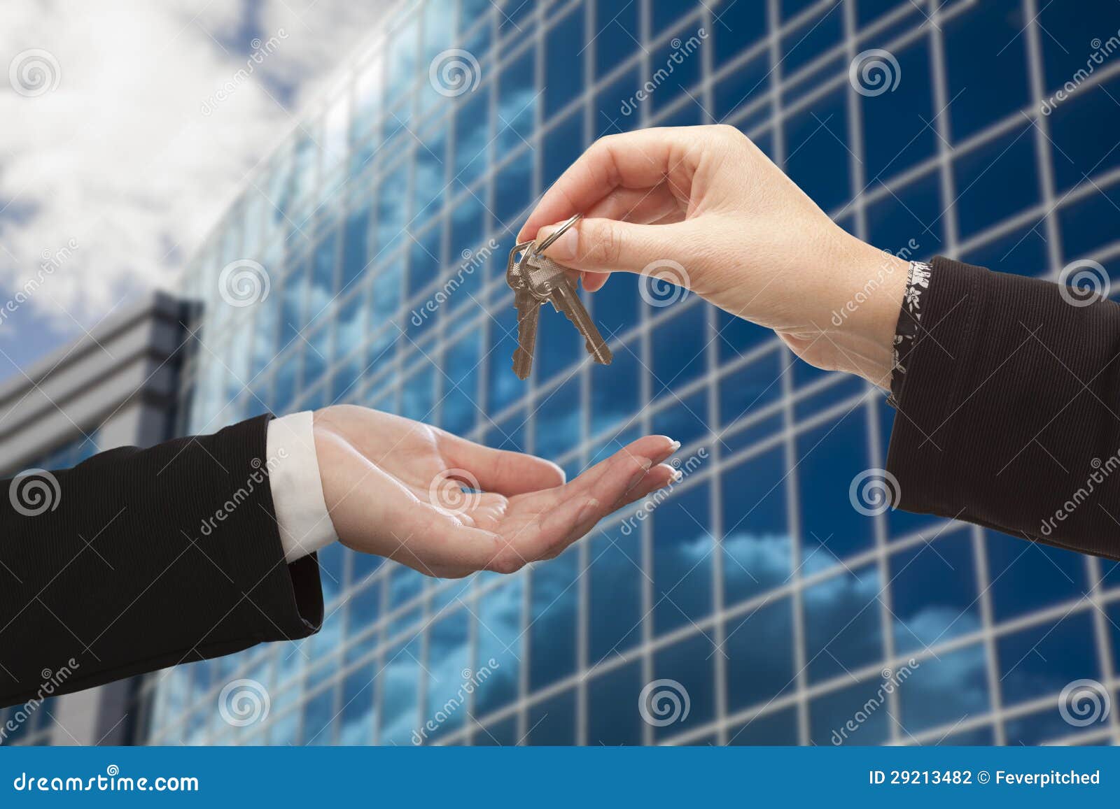 Female Handing Over the Keys in Front of Corporate Building Stock Photo ...