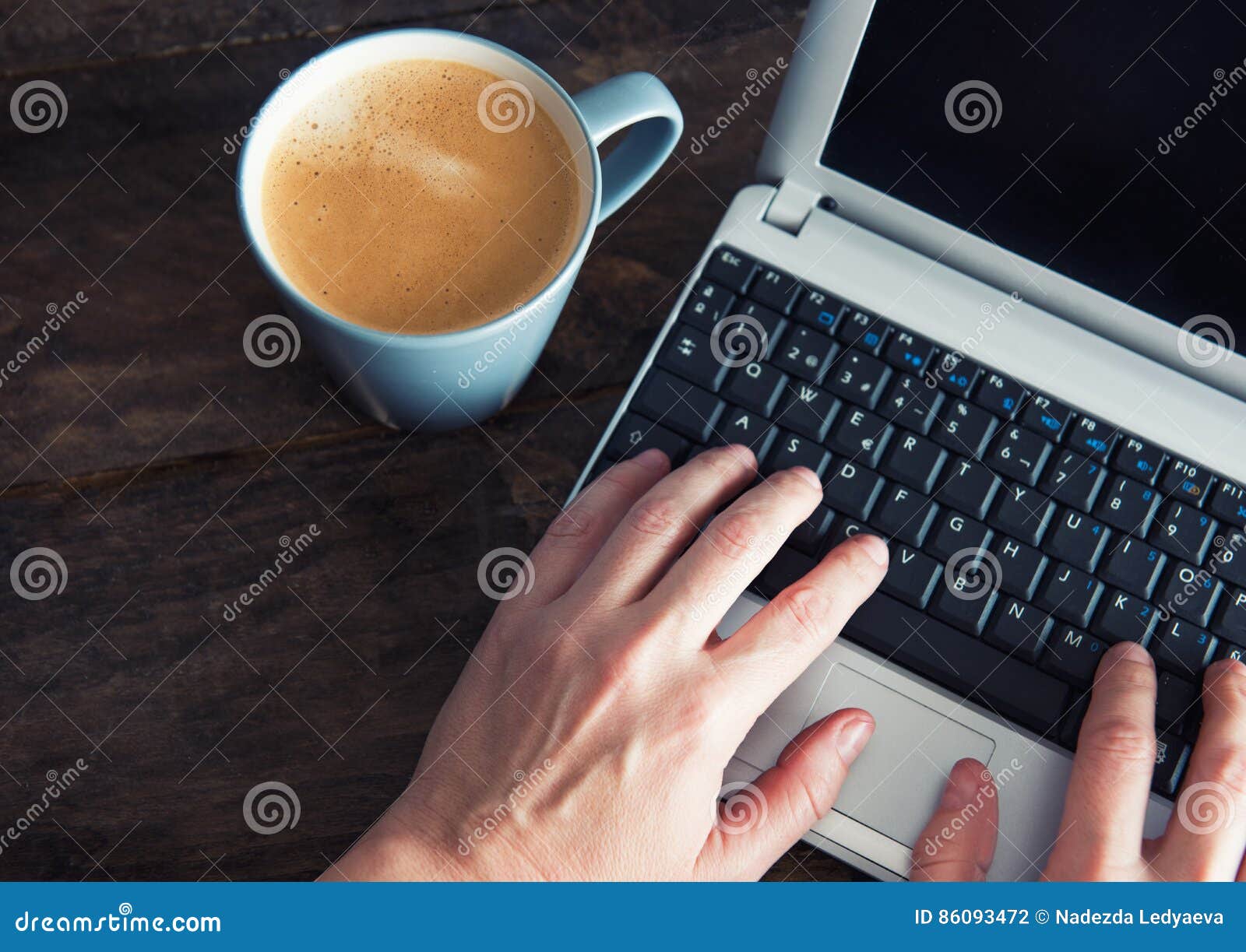 Female Hands on a Computer and Coffee on a Wooden Background Stock ...