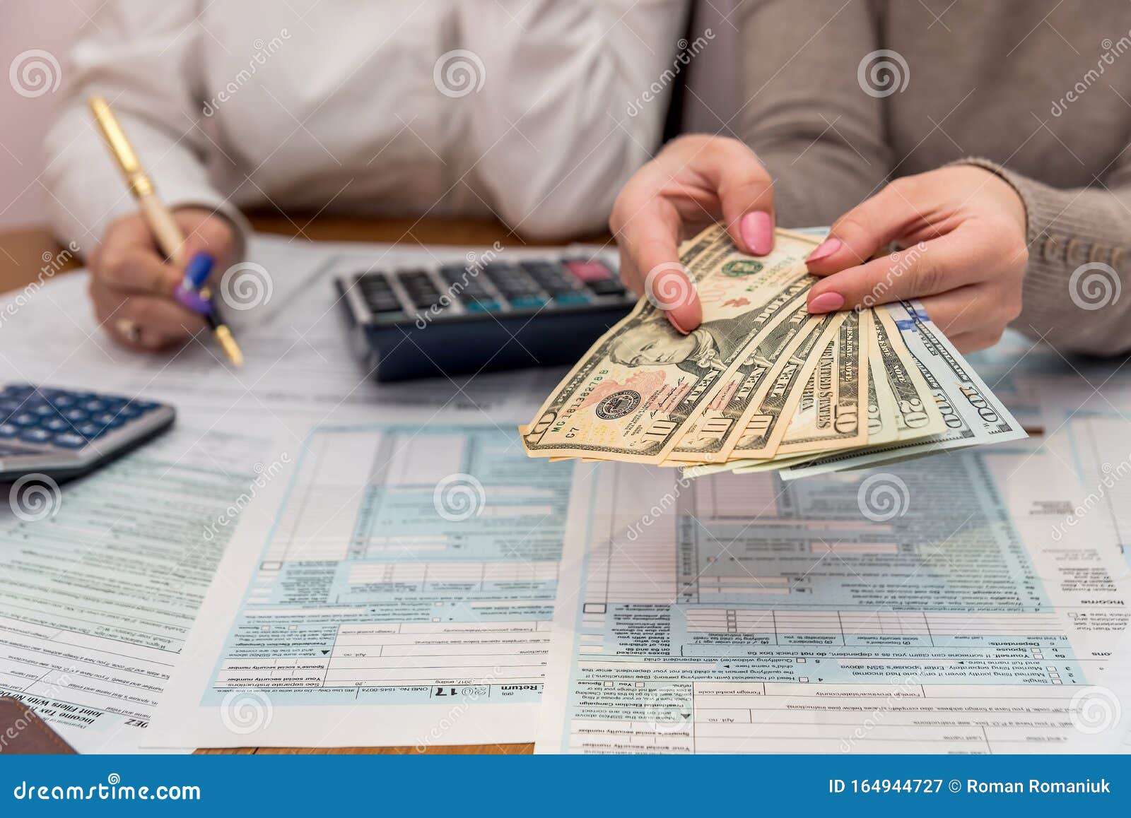 Female Hands with Dollar and 1040 Tax Form Stock Image - Image of ...