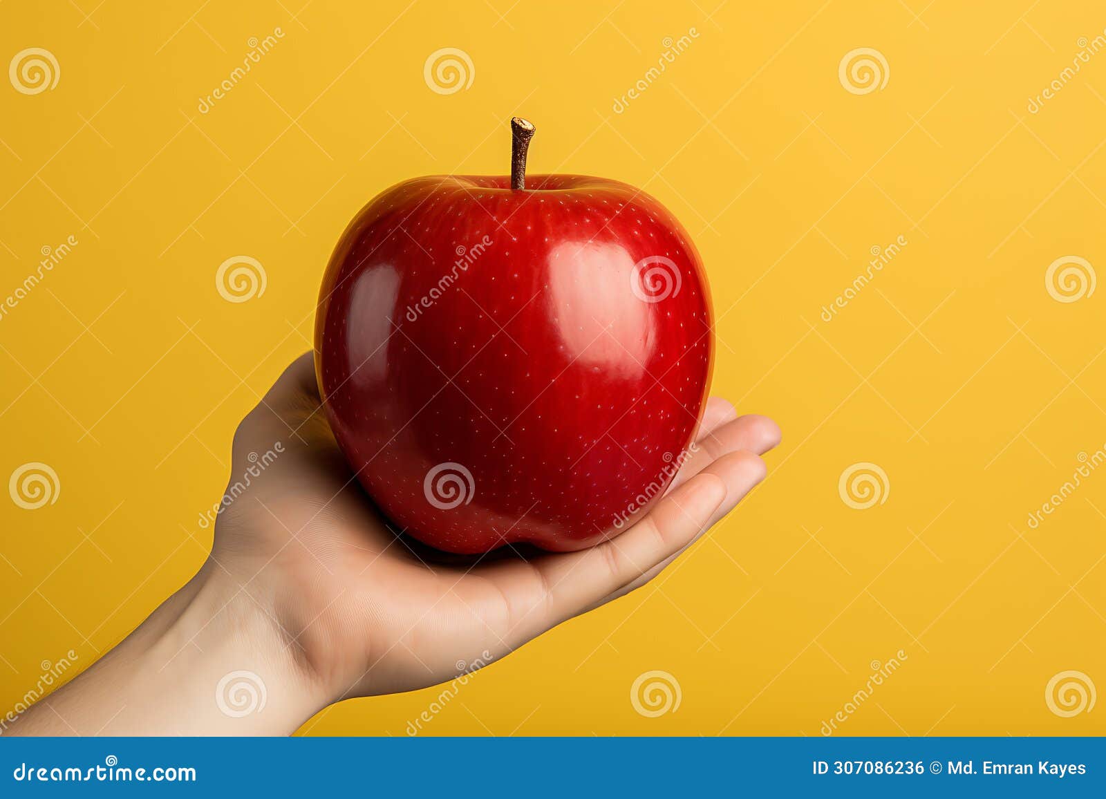 Female Hands Hold A Red Apple On A Yellow Background The Concept Of