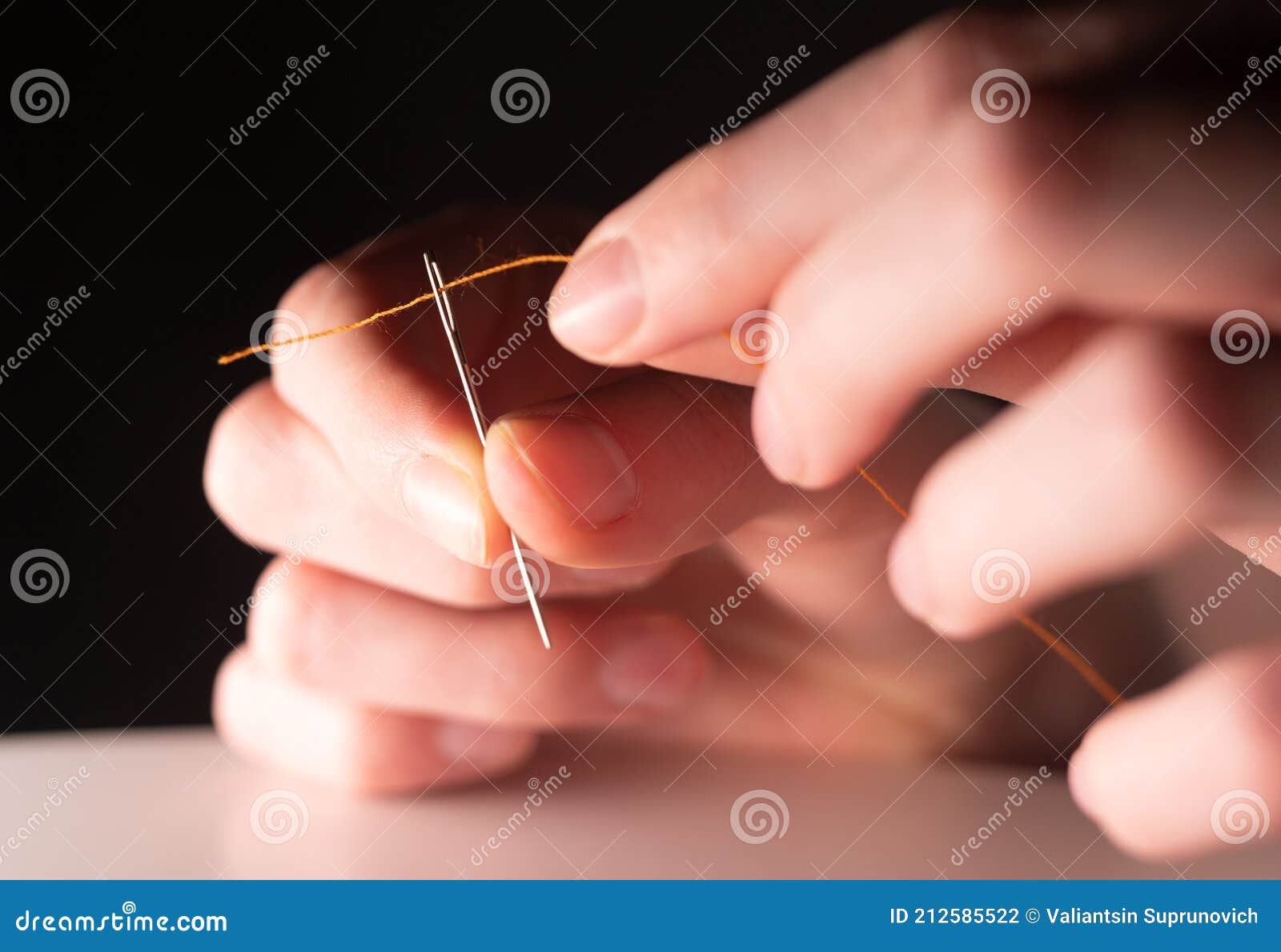 Female Hands Inserting Thread into Needle Ear or Hole Stock Photo ...
