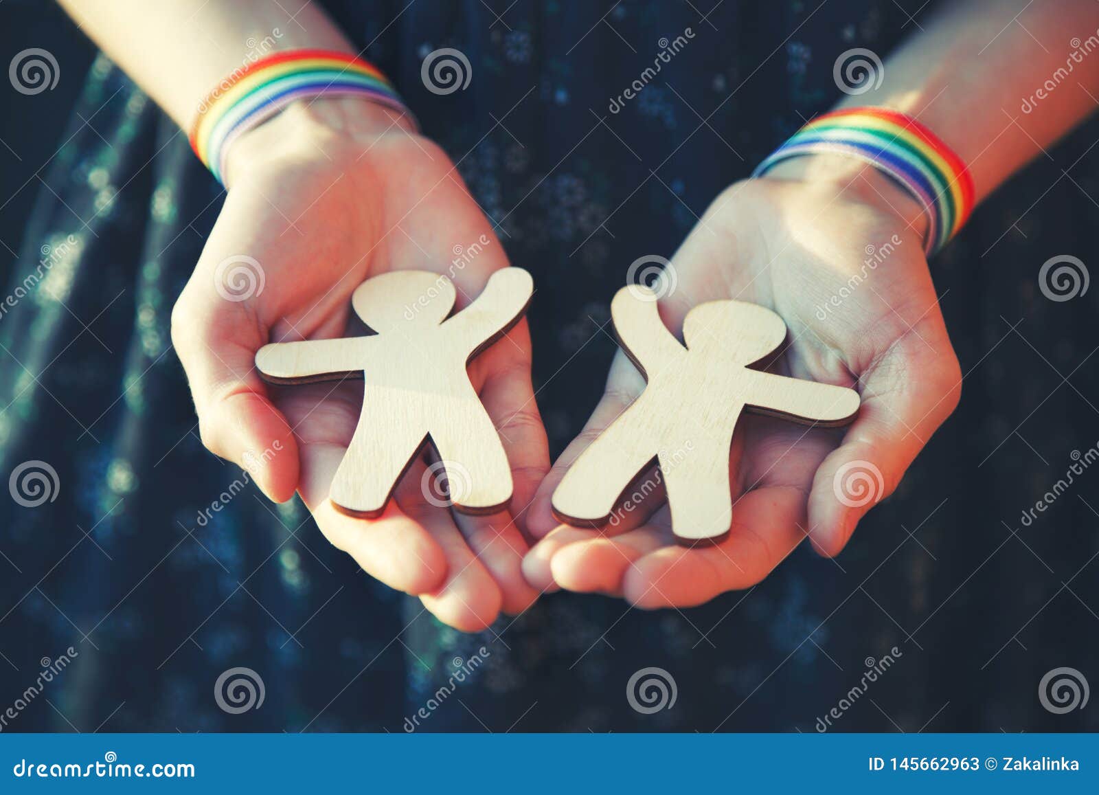 Emale Hands With Lgbt Rainbow Ribbon Wristbands Holding Couple Of Mini