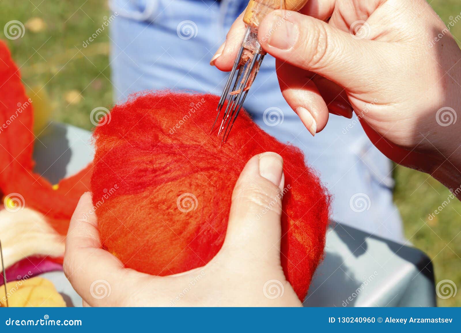 Female Hands Make a Needle Using Needle Felting from Red Wool Using the ...
