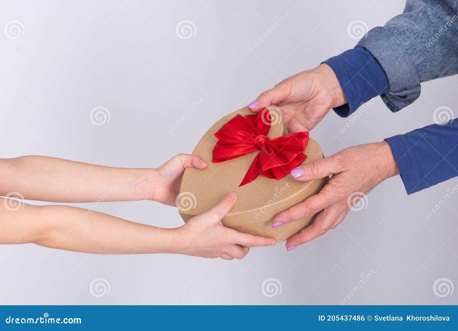 Female Hands Pass a Box with a Gift into the Hands of a Child Stock ...