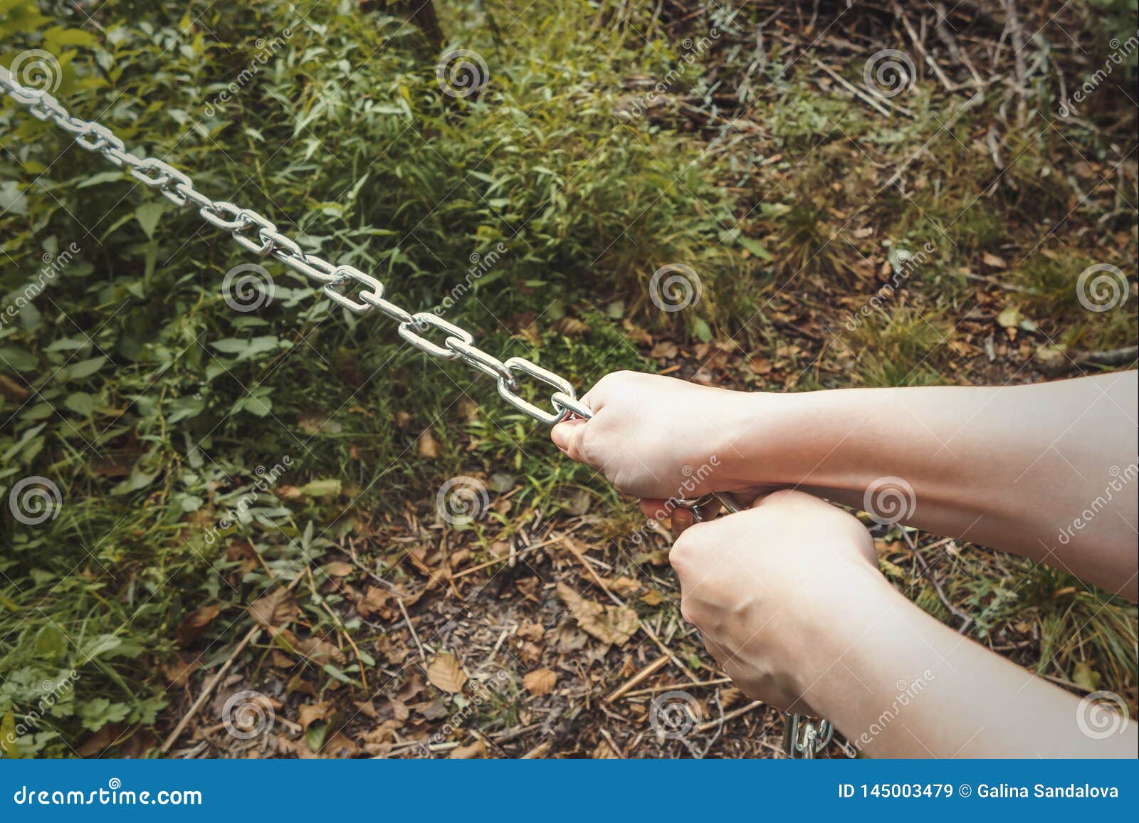 Female Hands Pulling a Thick Metal Chain - the Concept of Hard Work ...