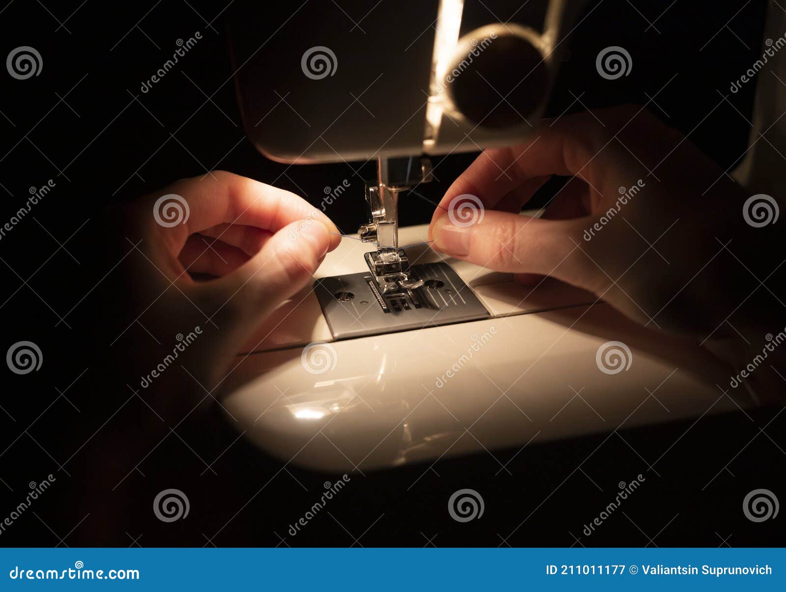 Female Hands of Tailor or Needlewoman Insert Thread into Needle in ...