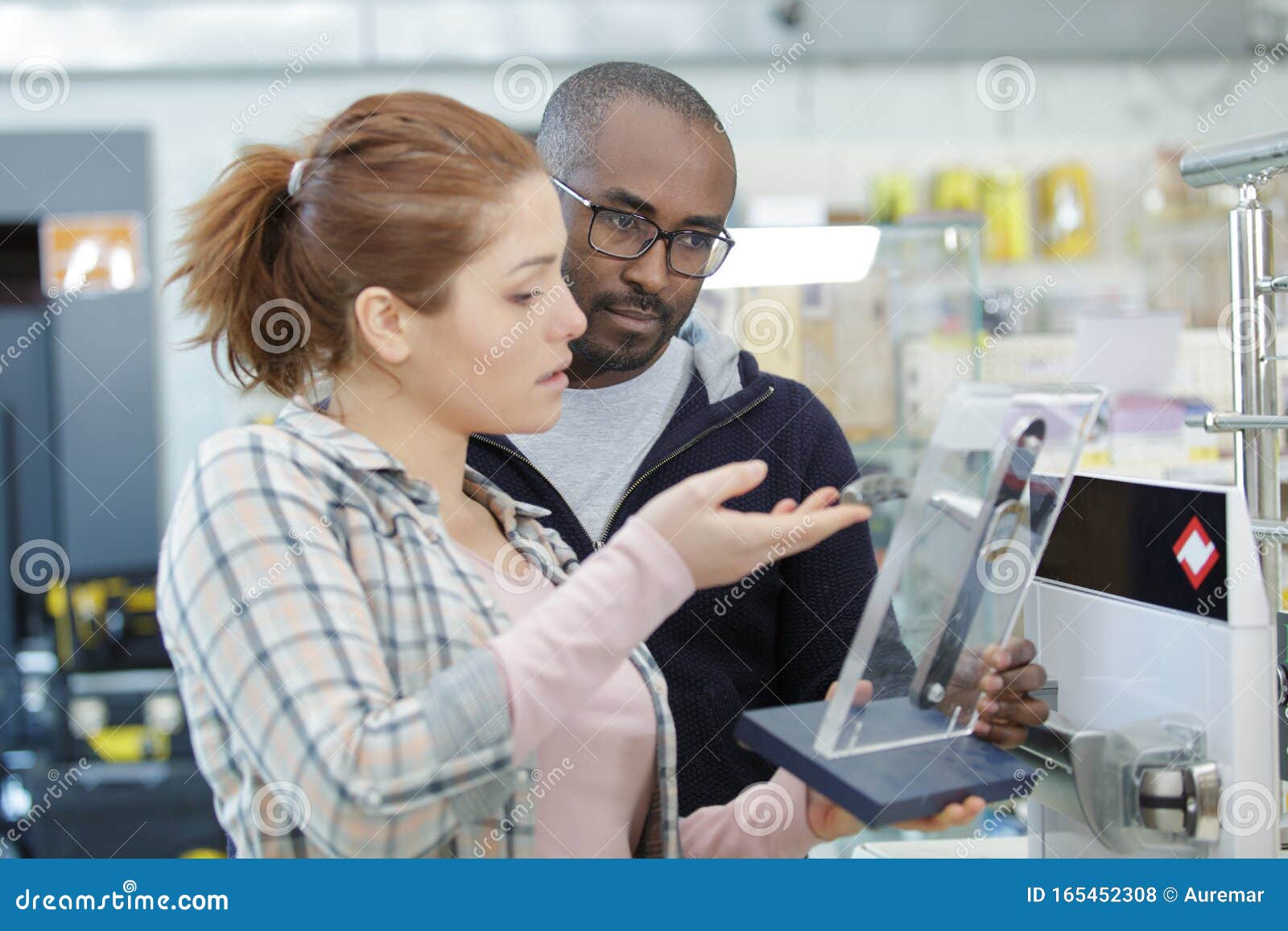 Female Hardware Store Seller Talking To Client Stock Photo - Image of ...
