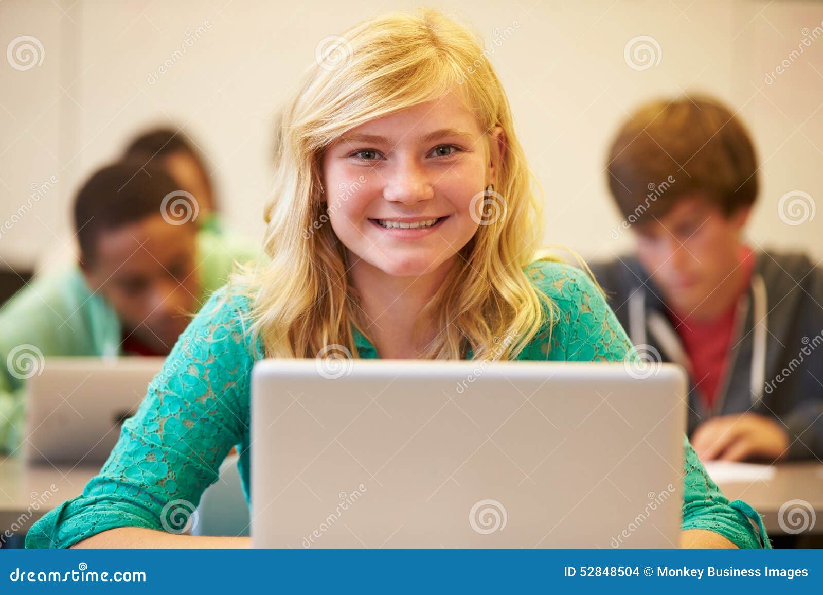 Female High School Student at Desk in Class Using Laptop Stock Photo ...