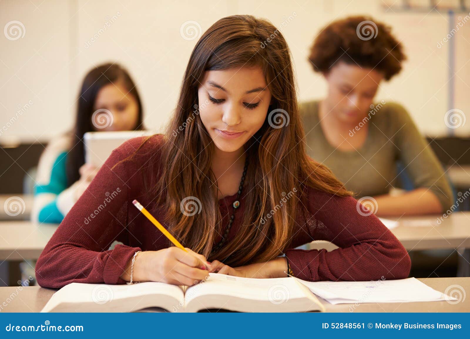Female High School Student Studying at Desk in Classroom Stock Image ...