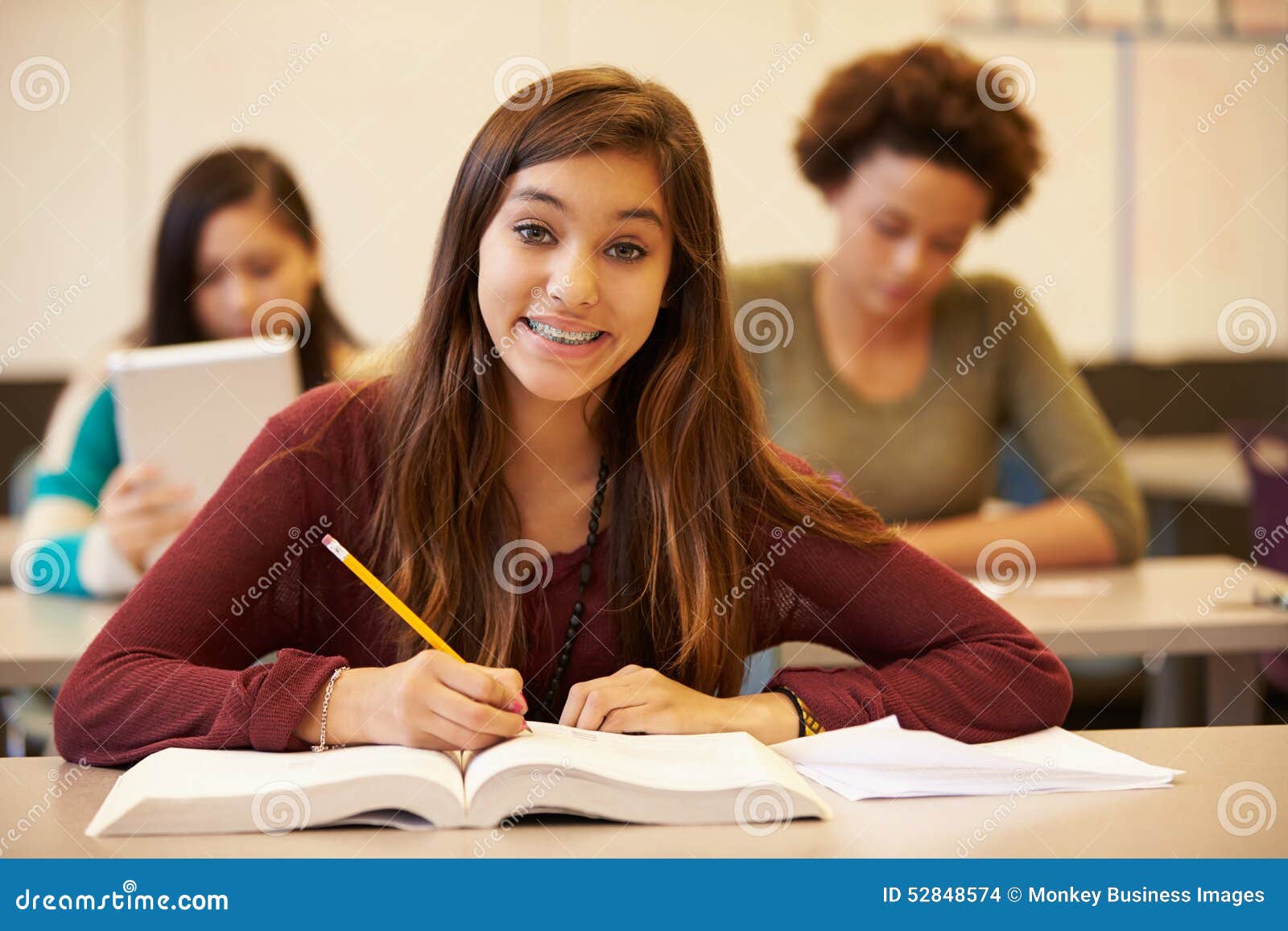 Female High School Student Studying at Desk in Classroom Stock Photo ...
