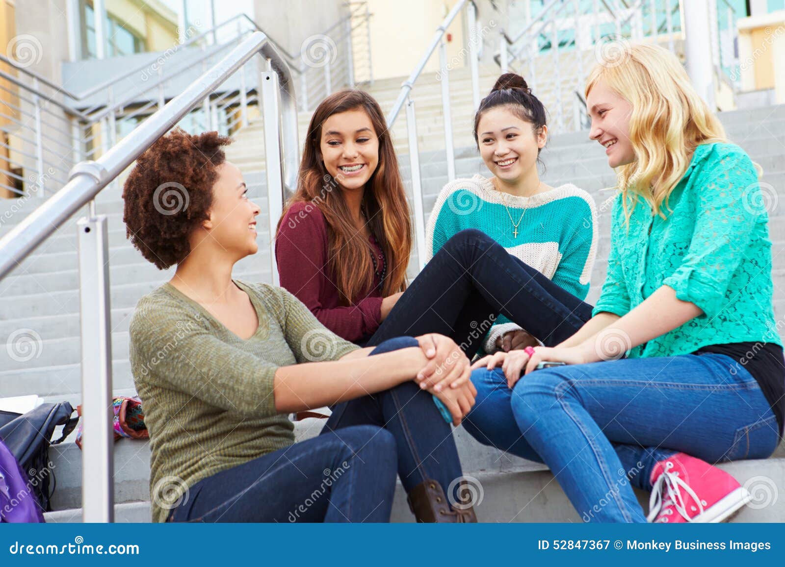 Female High School Students Sitting Outside Building Stock Image ...