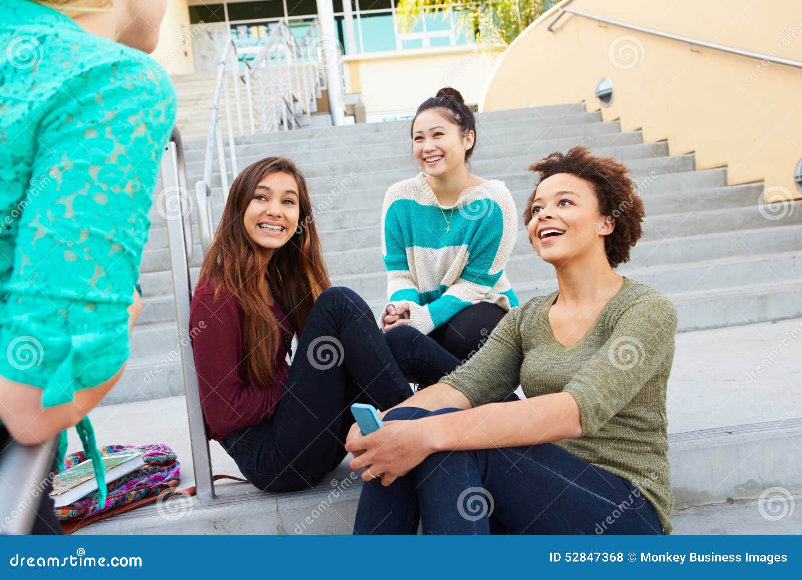Female High School Students Sitting Outside Building Stock Photo ...