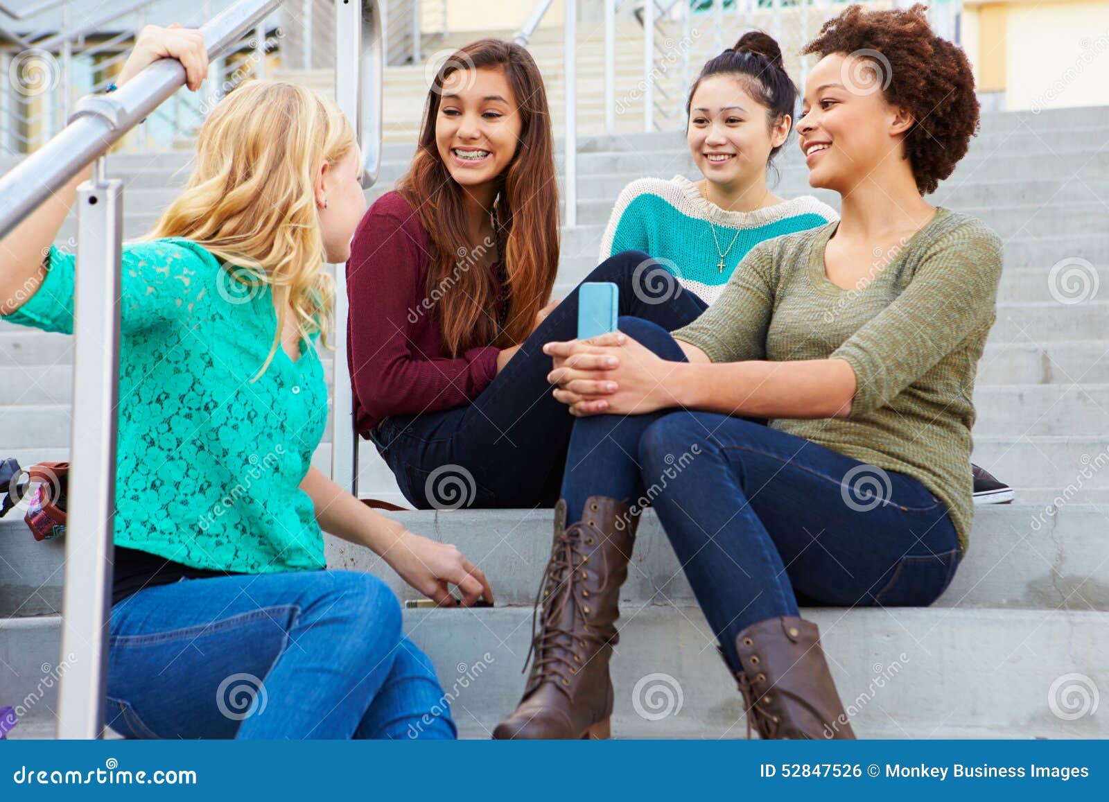 Female High School Students Sitting Outside Building Stock Photo ...