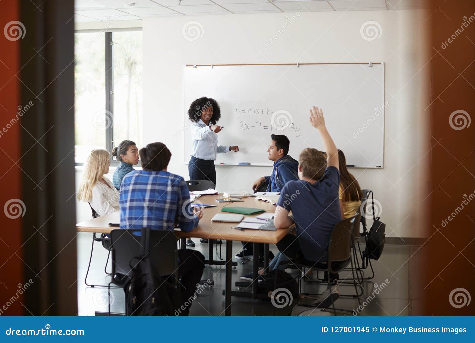 Female High School Tutor at Whiteboard Teaching Maths Class with Pupil ...