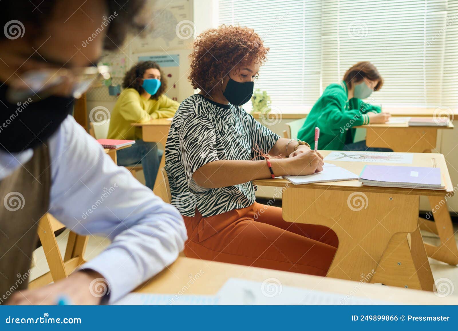 Female Highschool Student Writing Down Notes in Copybook among ...