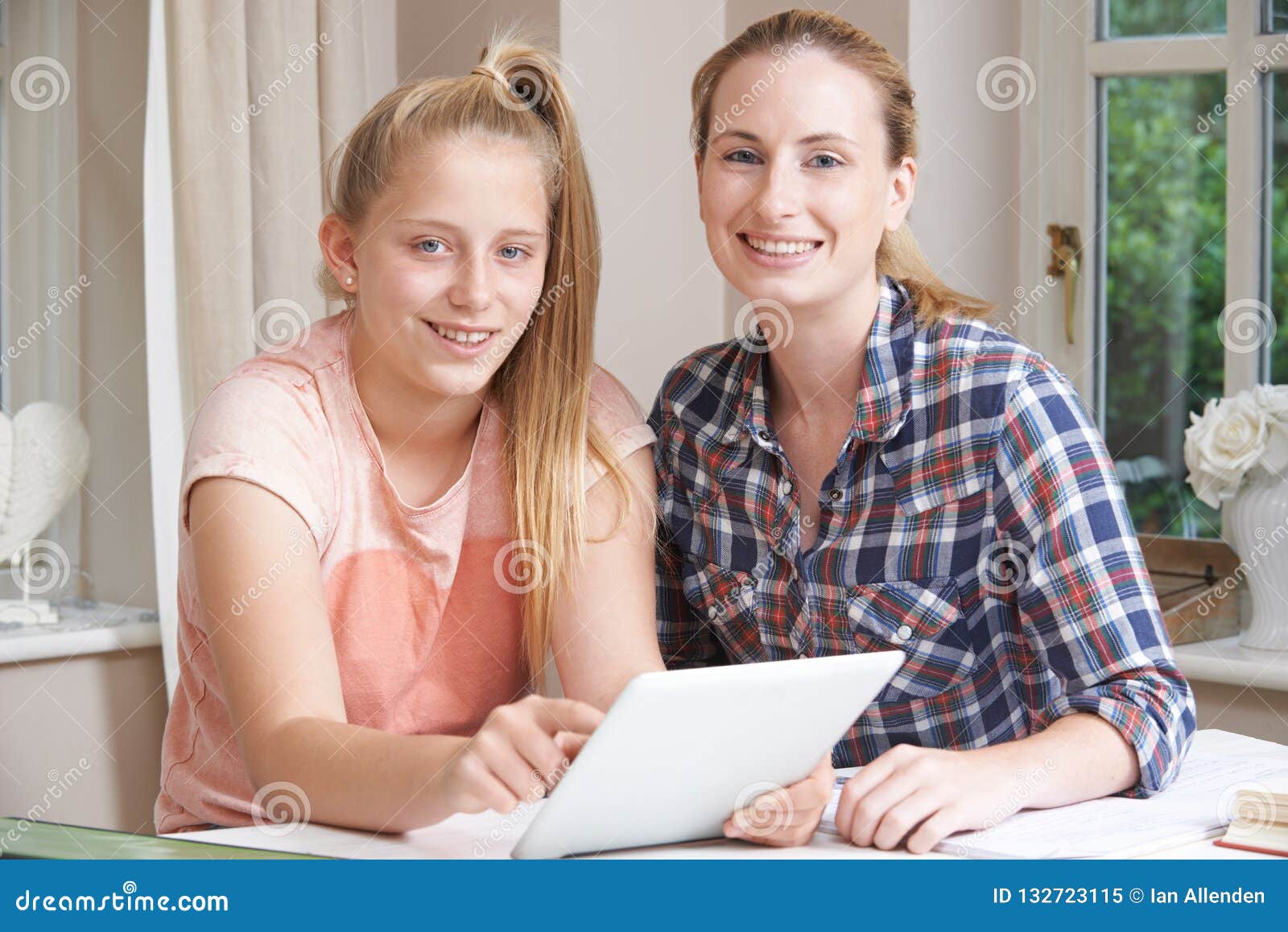 Female Home Tutor Helping Girl with Studies Using Digital Tablet Stock ...