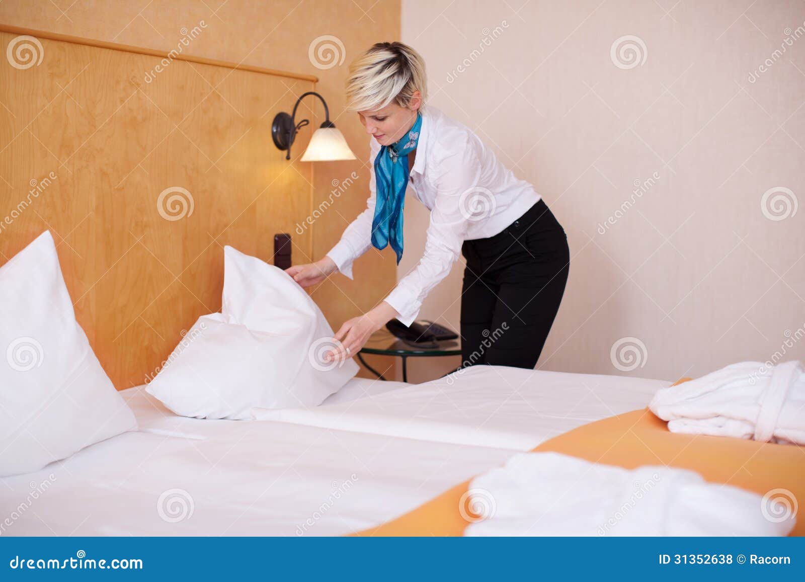 Female Housekeeper Making Bed in Hotel Room Stock Photo - Image of ...