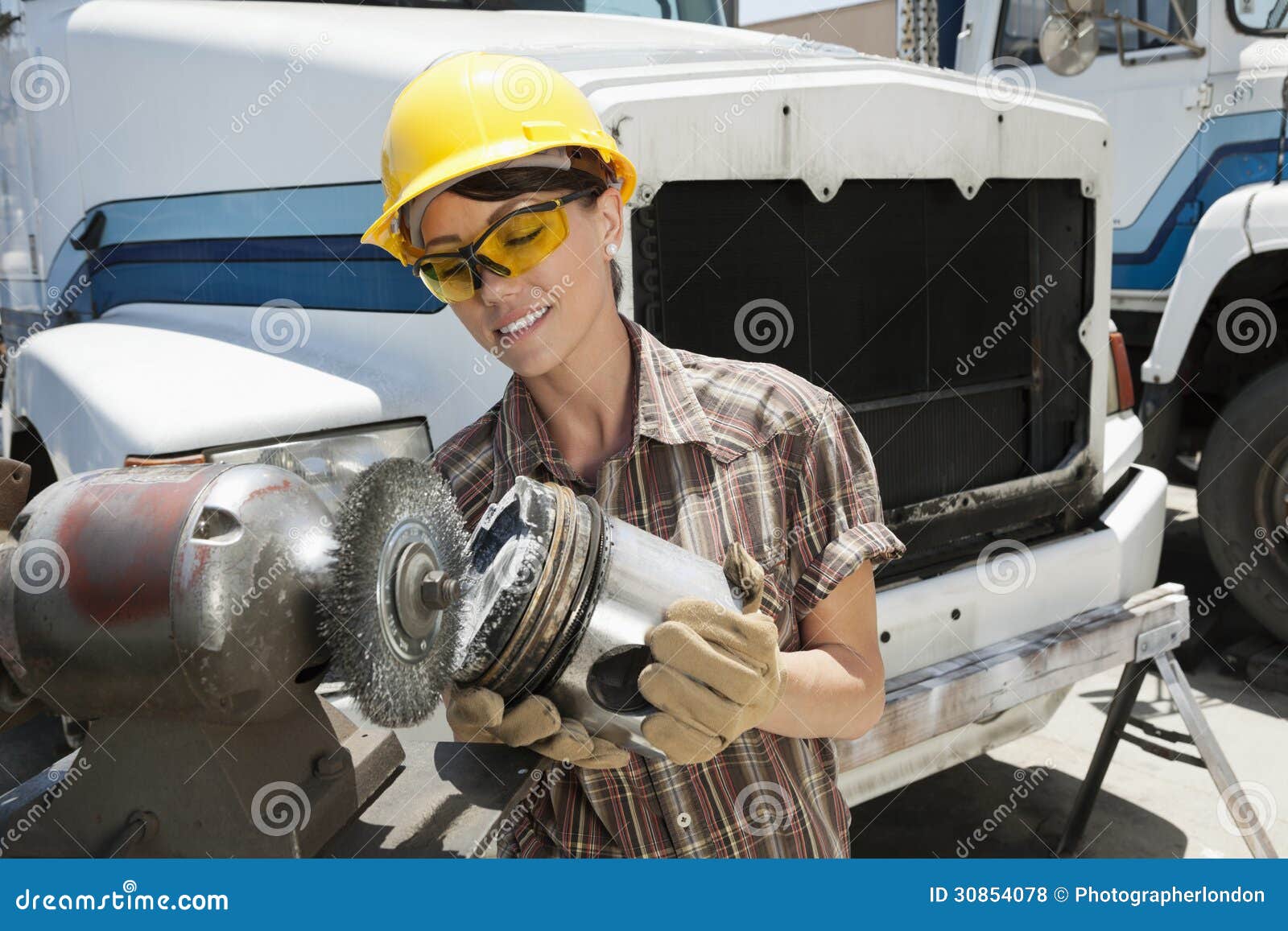 Female Industrial Worker Buffing a Truck Engine Cylinder Stock Photo ...