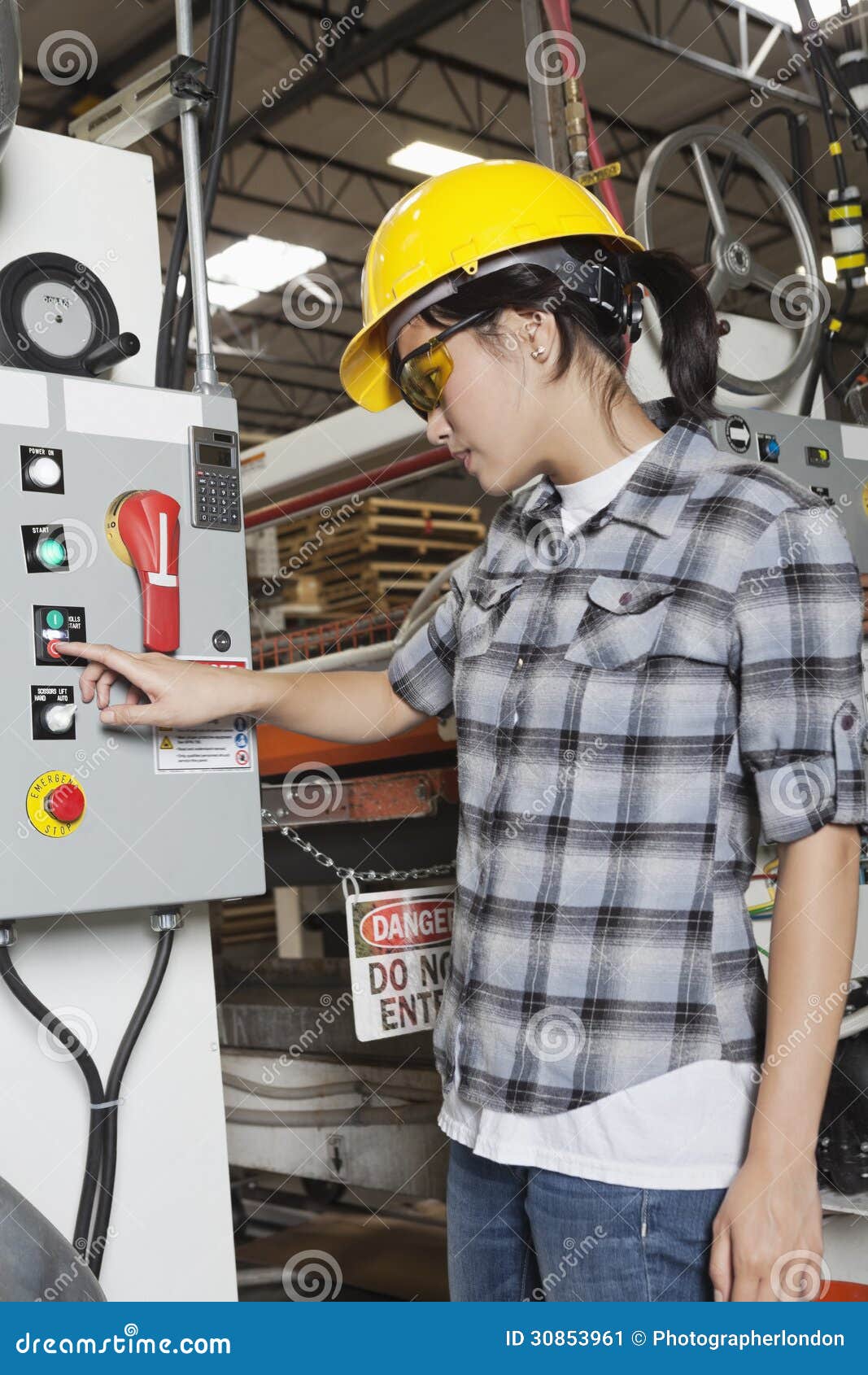Female Industrial Worker Operating Manufacturing Machine at Factory ...