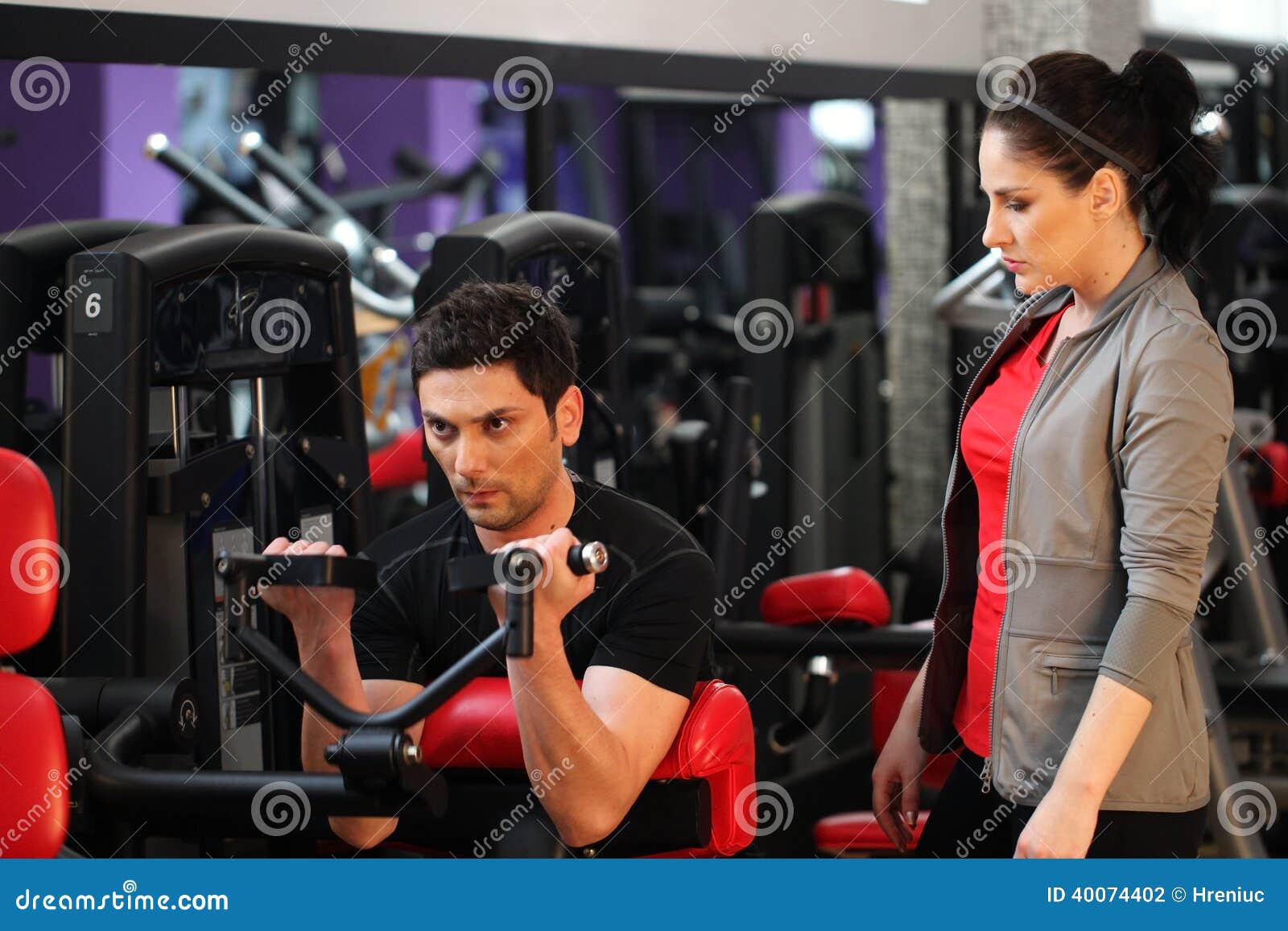 Female Instructor Explaining To a Man How To Workout Stock Photo ...