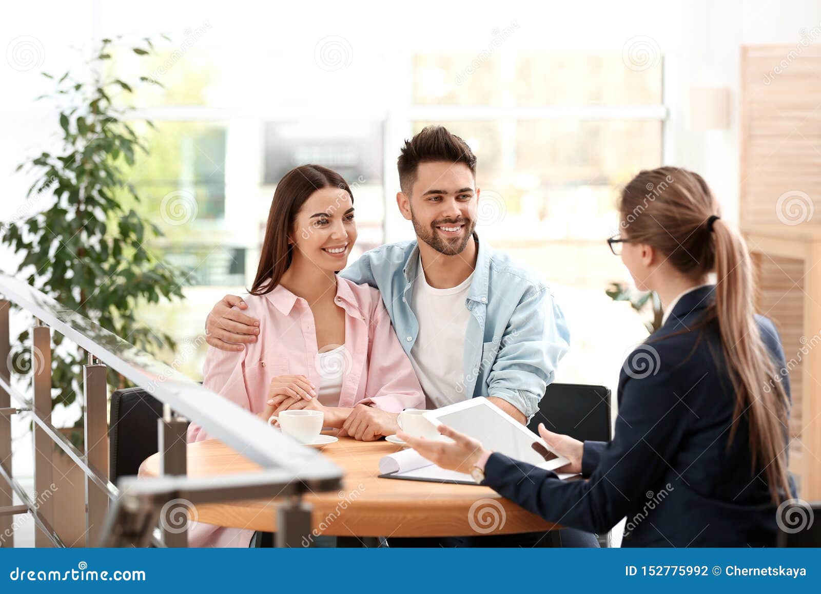 Female Insurance Agent Working with Young Couple Stock Photo - Image of ...