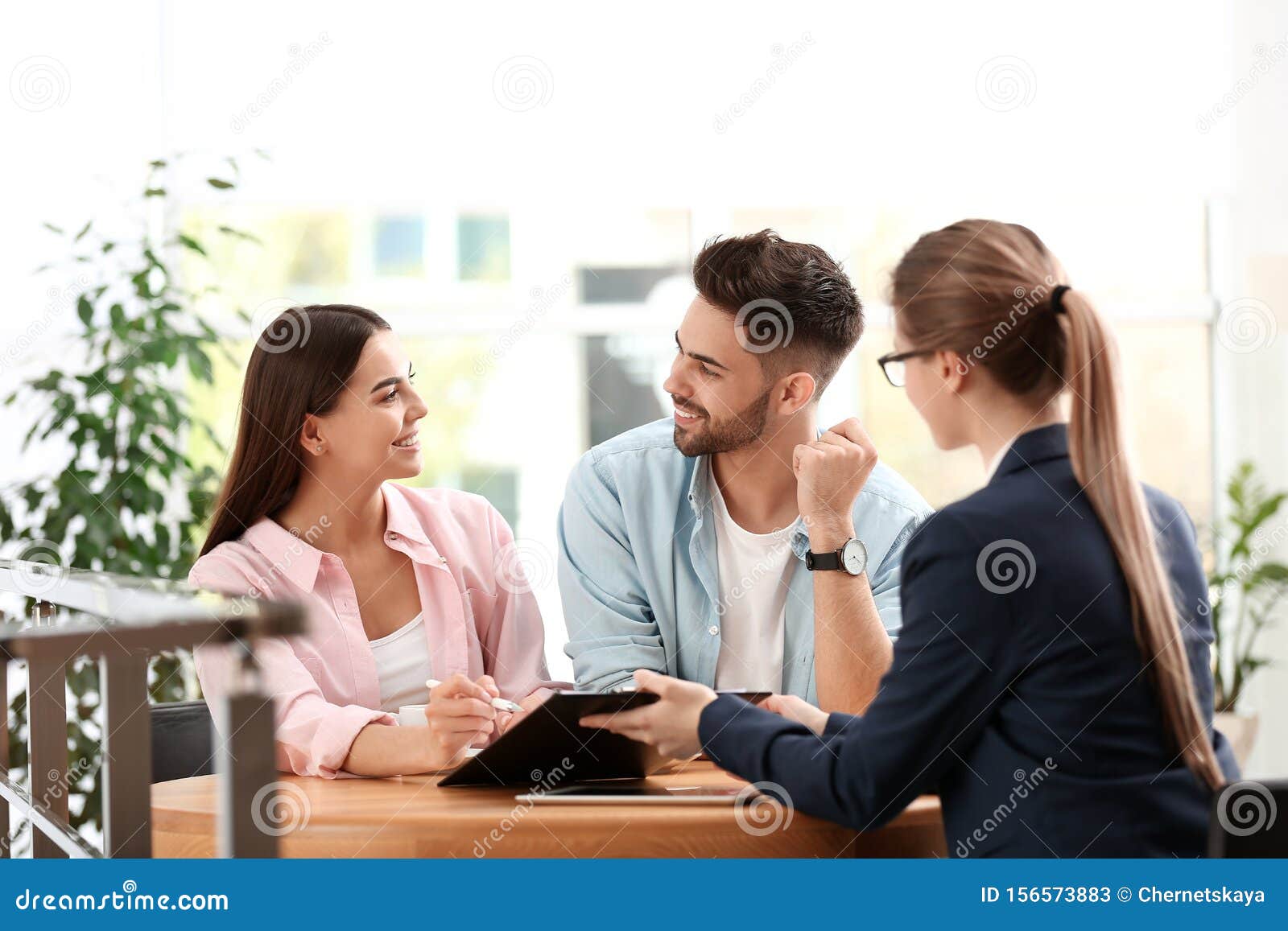 Female Insurance Agent Working with Couple in Office Stock Image ...