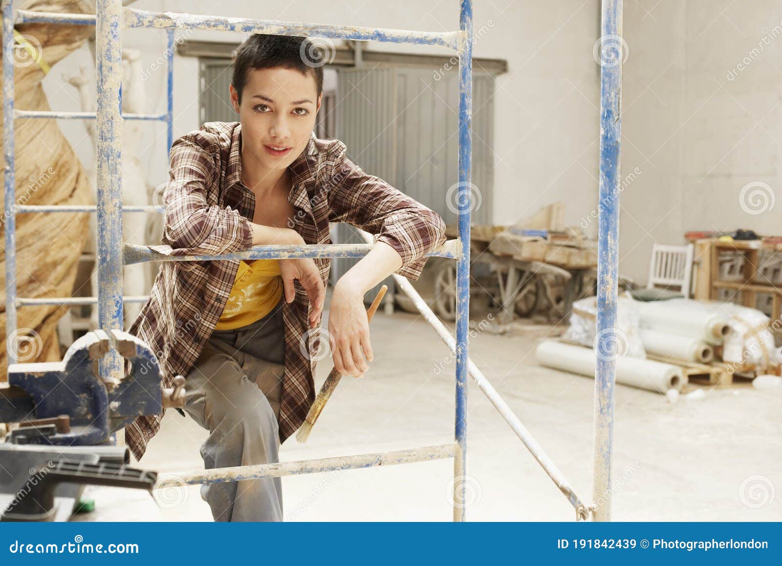 Female Interior Decorator Leaning on Scaffolding Portrait Stock Image ...