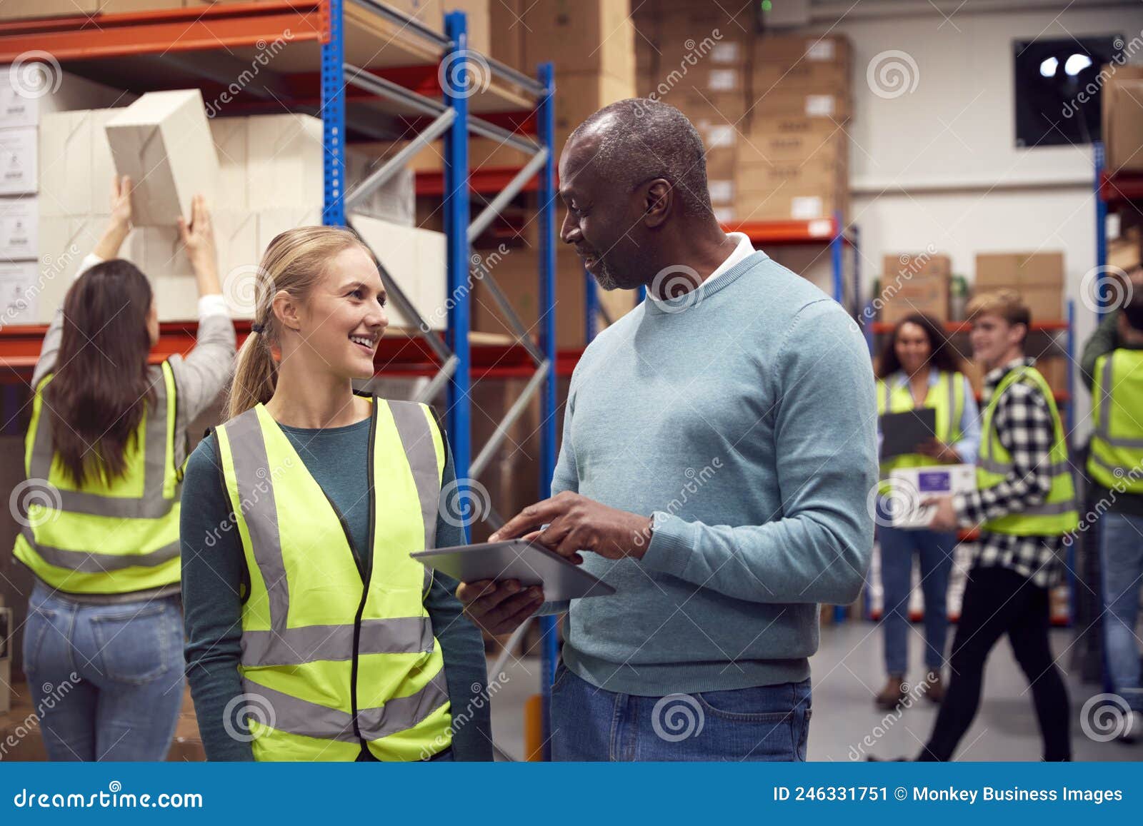 Female Intern with Team Leader Looking at Digital Tablet Inside Busy ...