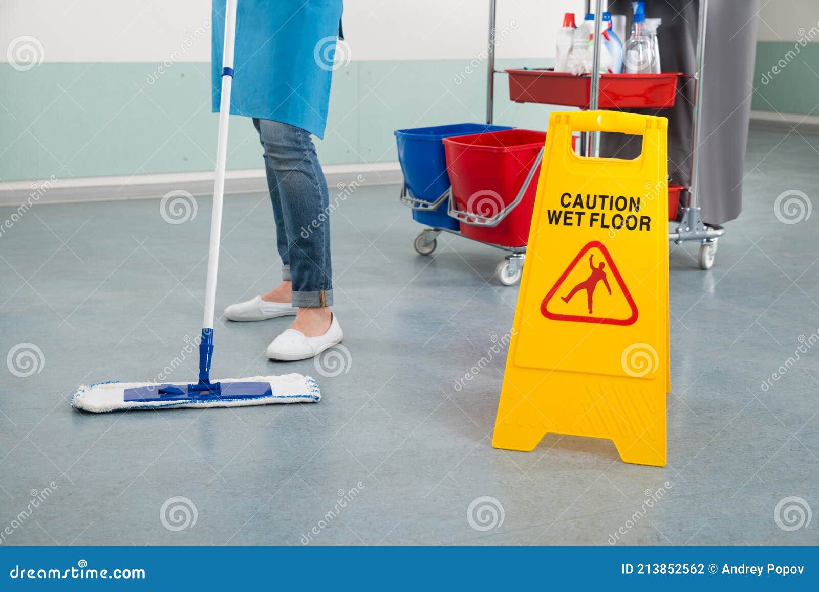 Female Janitor Mopping Corridor with Caution Sign Stock Photo - Image ...