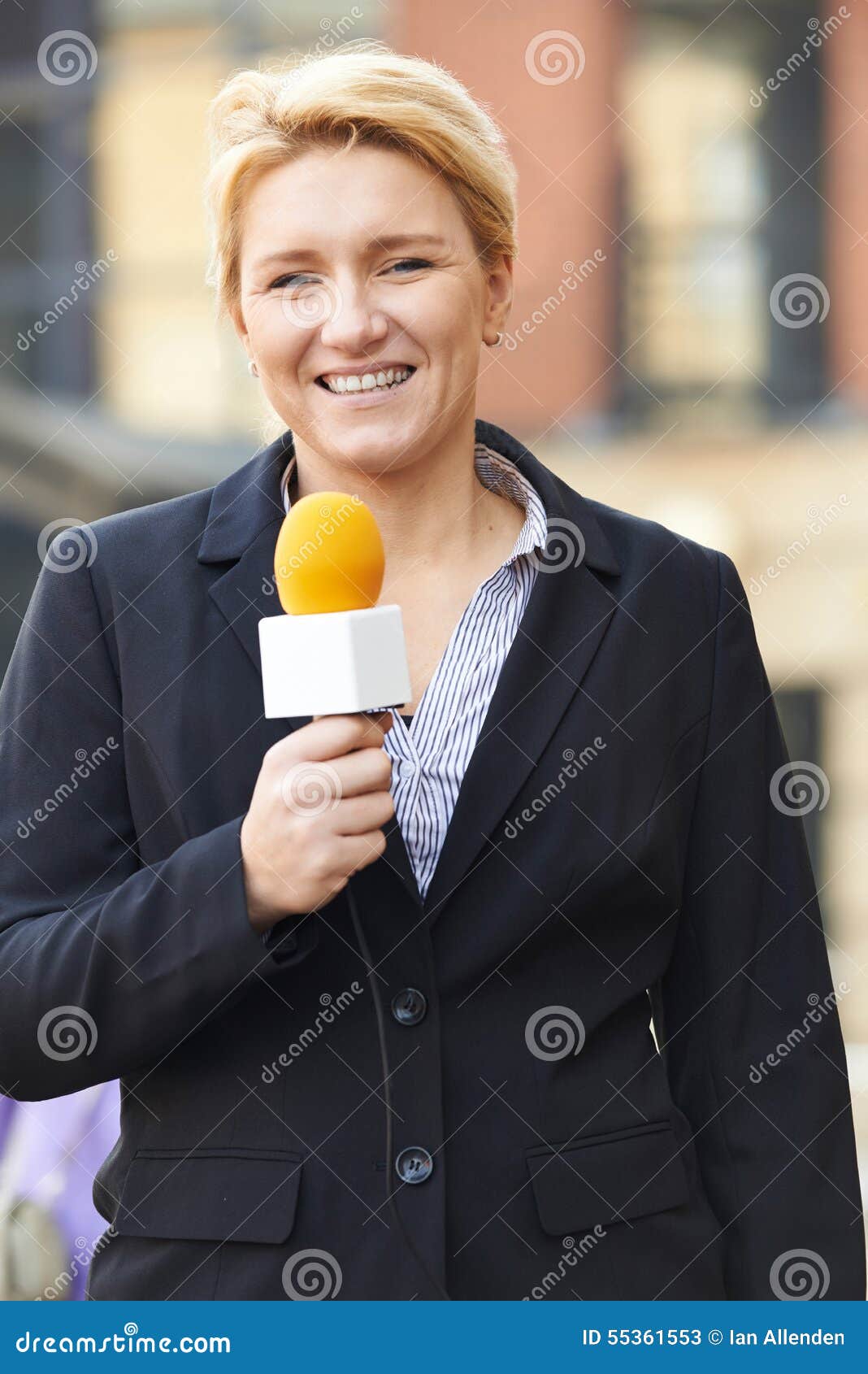 Female Journalist Broadcasting Outside Office Building Stock Image ...