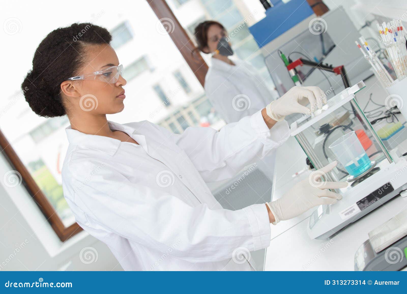 Female Lab Assistant Studying Blood Sample for Analysis Stock Photo ...