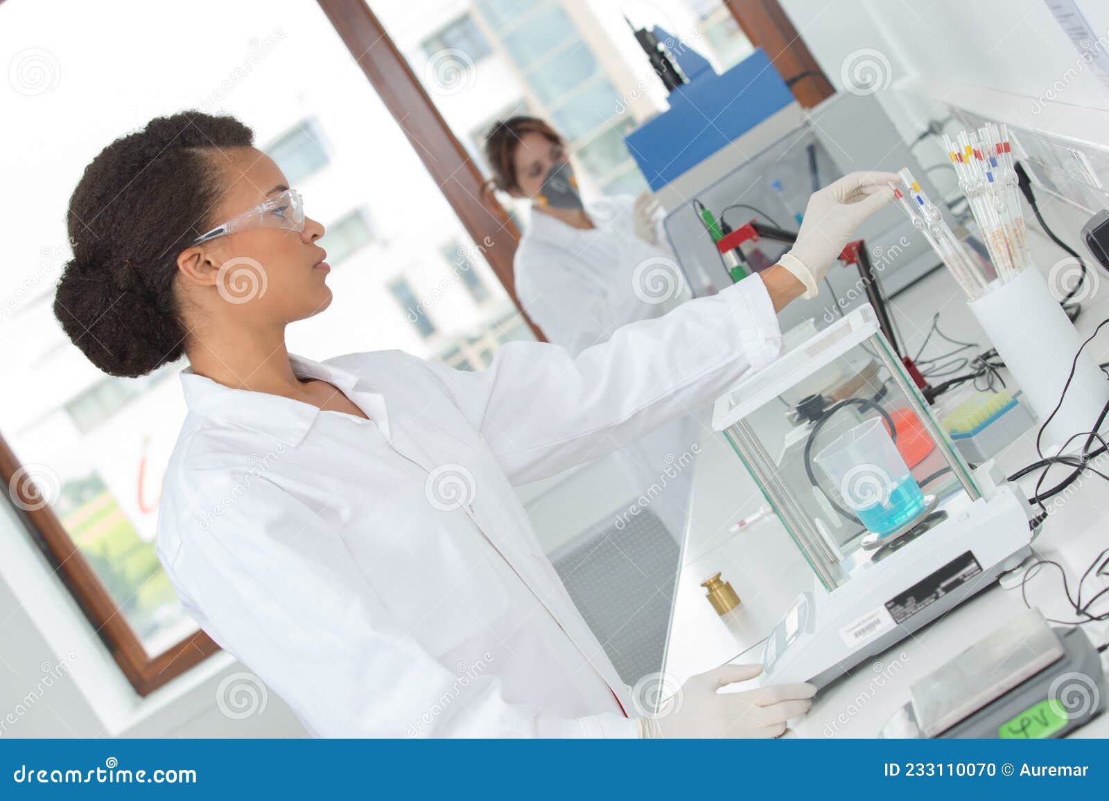 Female Lab Assistant Studying Blood Sample for Analysis Stock Photo ...